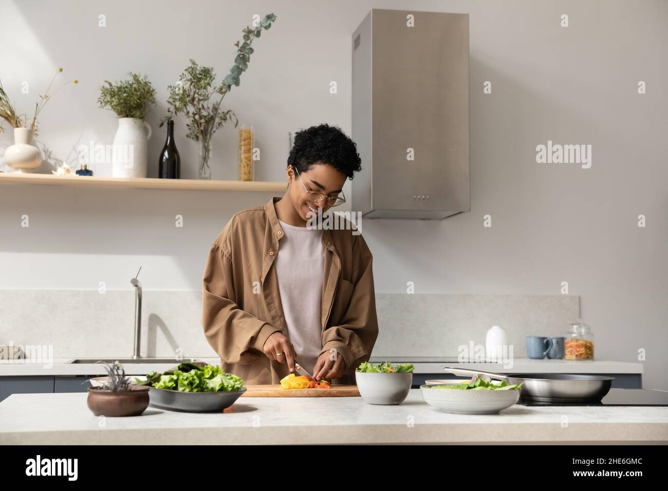 Happy pretty Black girl enjoying cooking hobby, chopping fresh ...