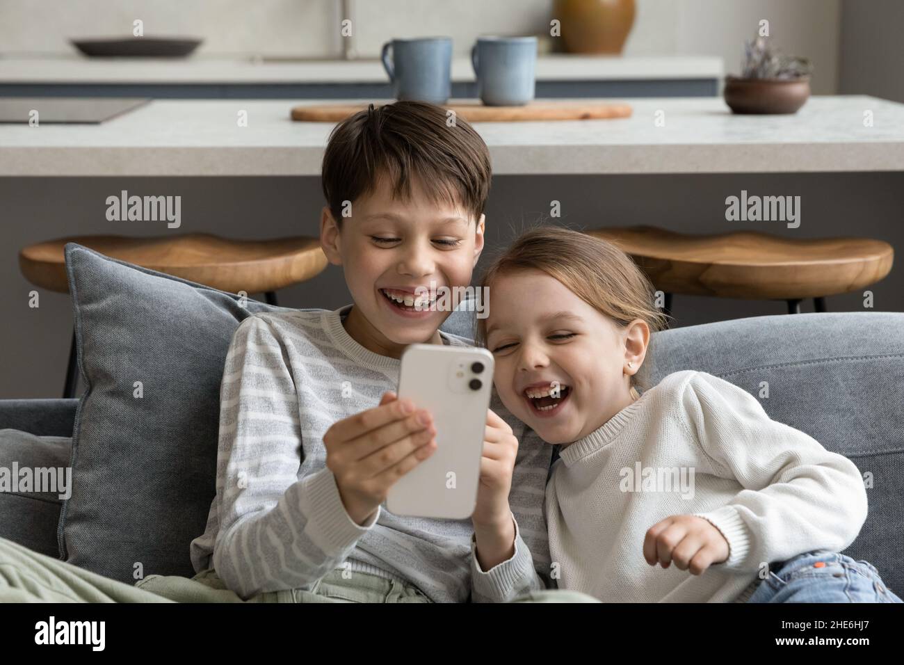 Happy cheerful sibling kids watching funny media on smartphone Stock ...
