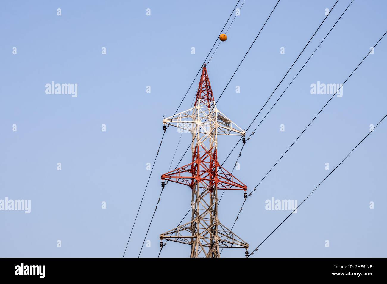 Aged high voltage electric tower under the clean blue sky with copy ...