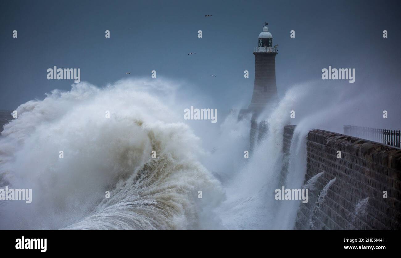 Giant waves batter the lighthouse & north pier guarding the mouth of ...