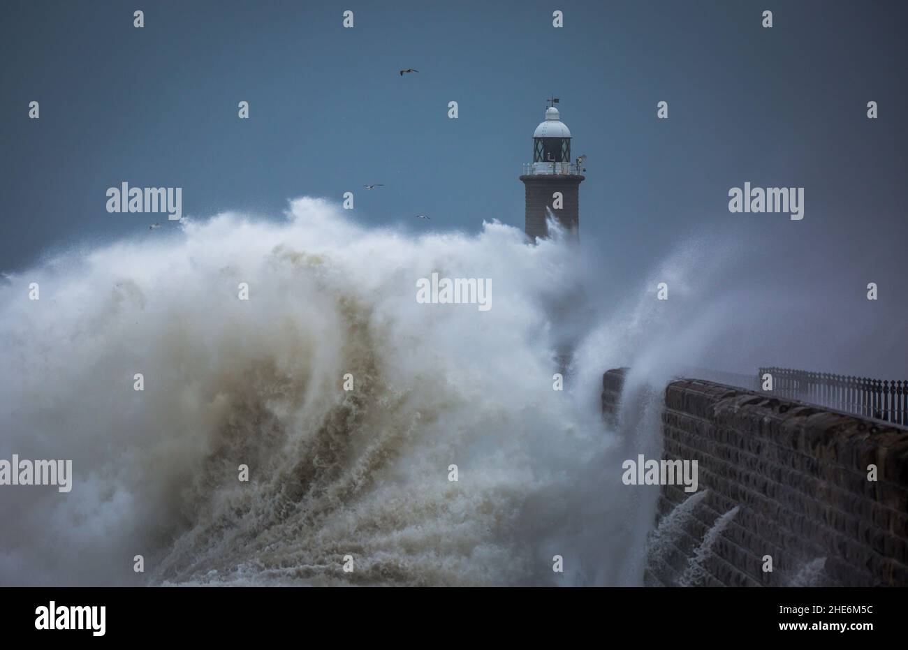 Giant waves batter the lighthouse & north pier guarding the mouth of ...