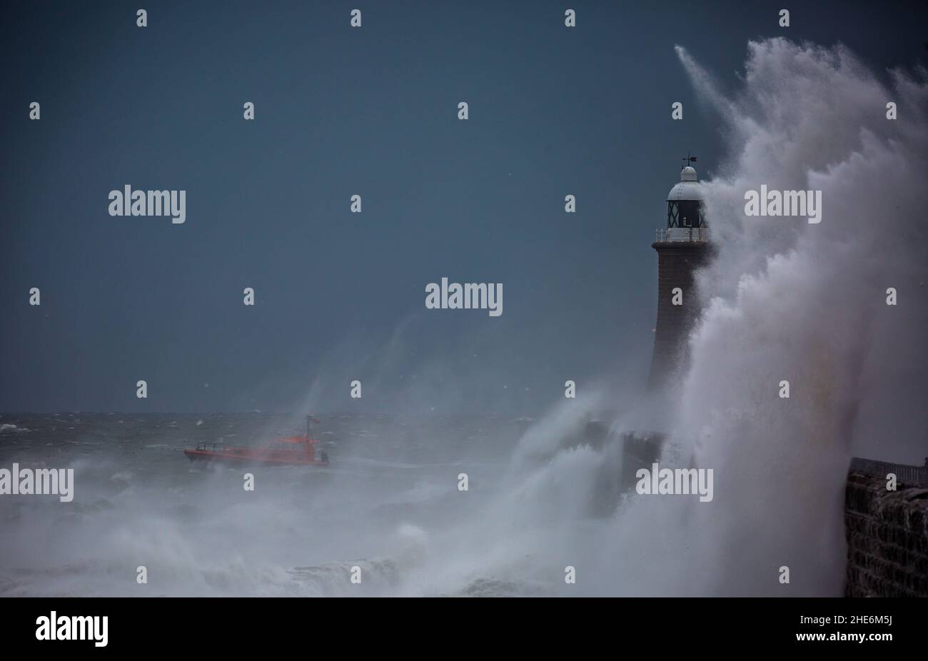 Giant waves batter the lighthouse & north pier guarding the mouth of ...