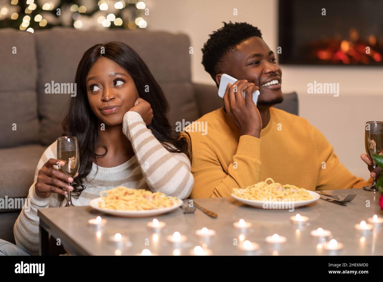 Woman Waiting While Man Talking On Cellphone During Dinner Indoor Stock ...