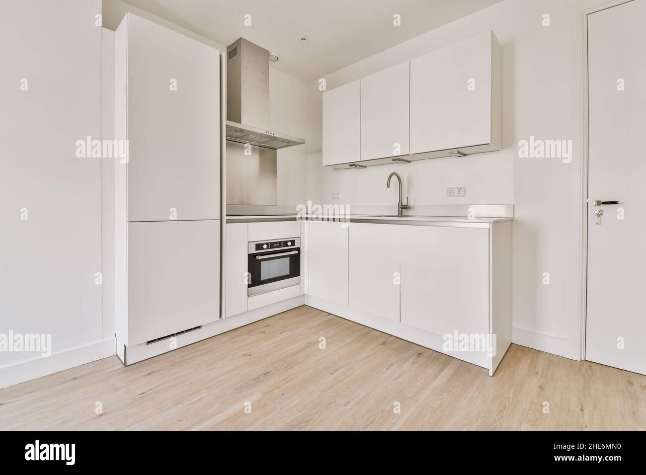 Light cozy small kitchen with white kitchen unit and parquet floor ...