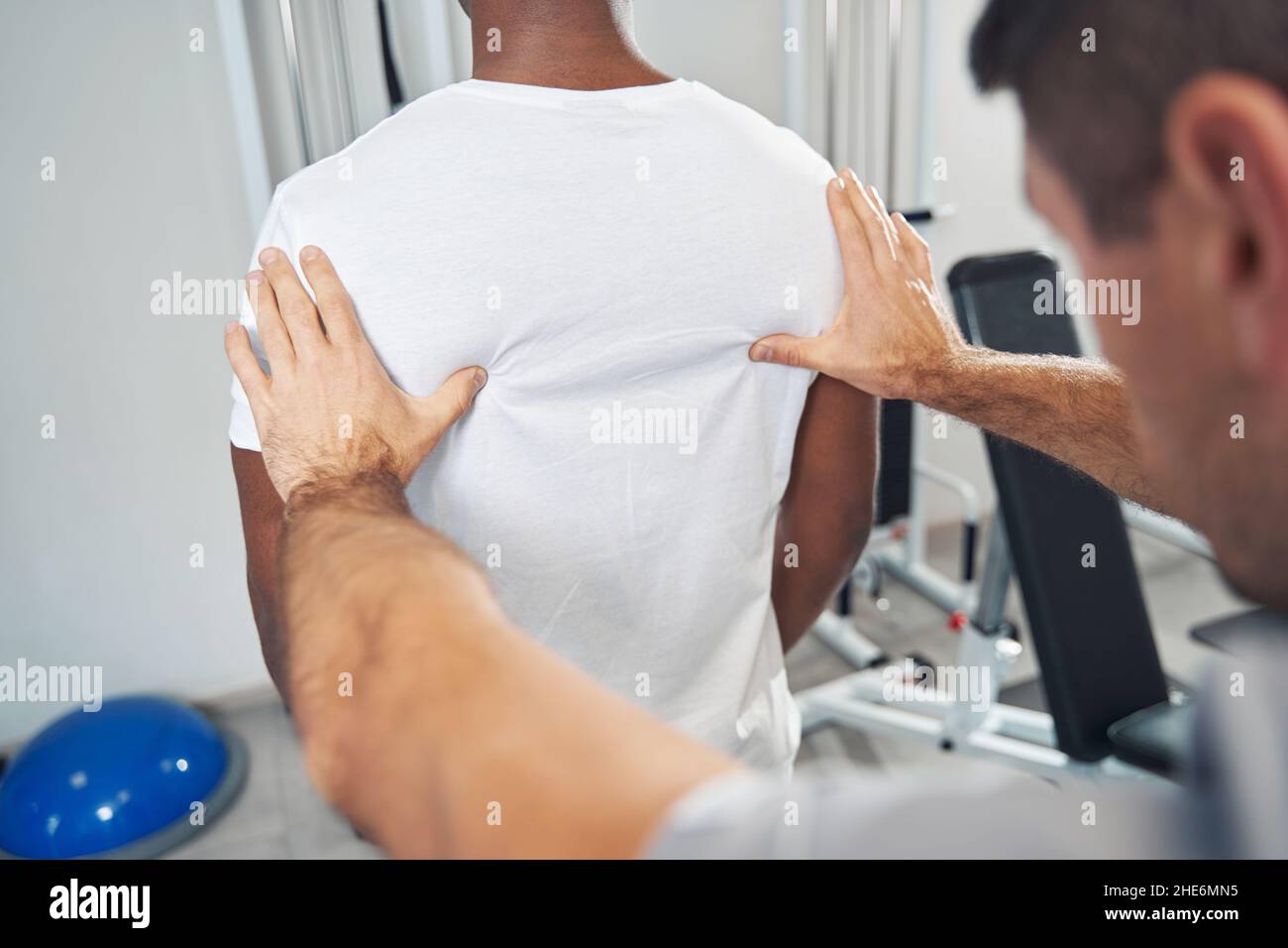 Professional physical therapist palpating patient paraspinal muscles ...