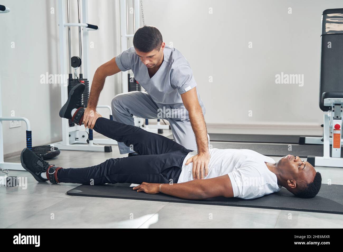 Physiotherapist performing straight leg raise test on patient Stock ...