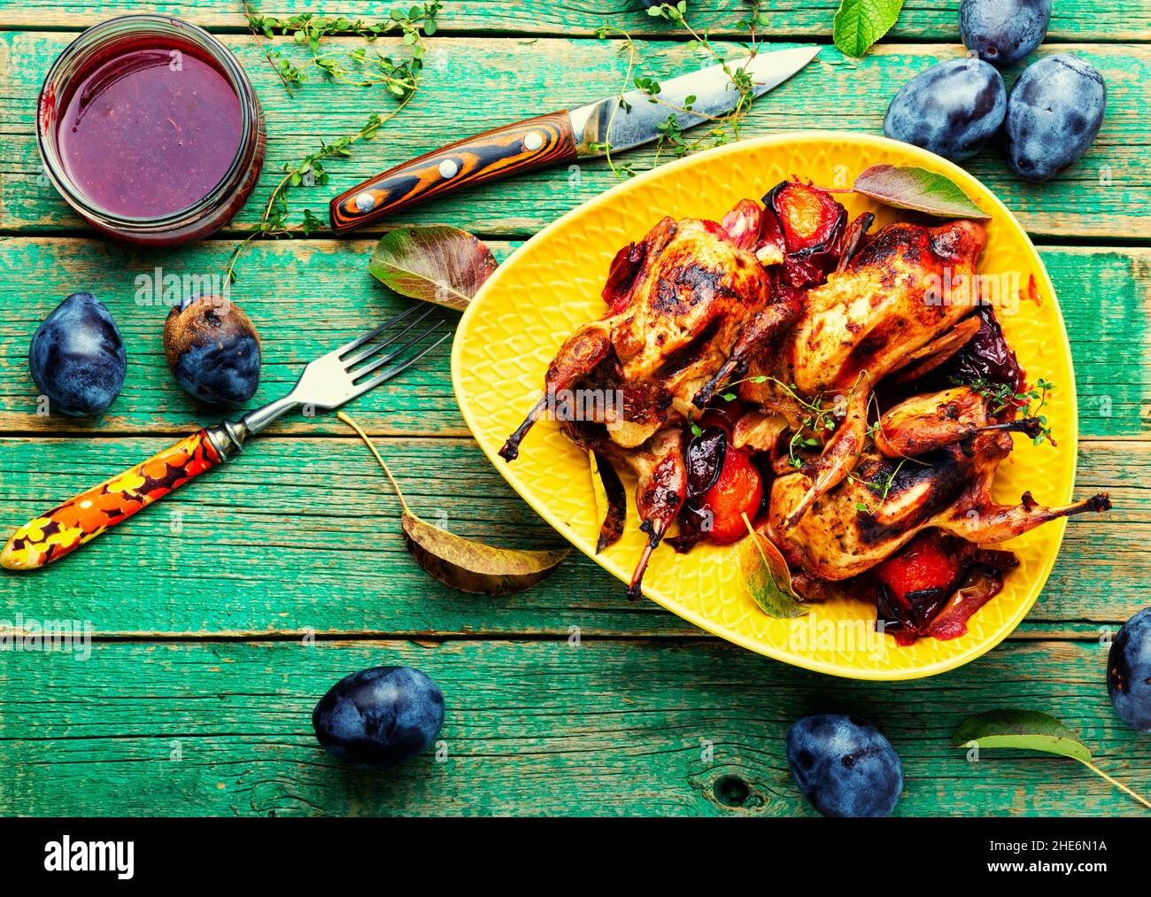 Roasted whole quail in plum sauce. Tasty grilled quails with plum Stock ...