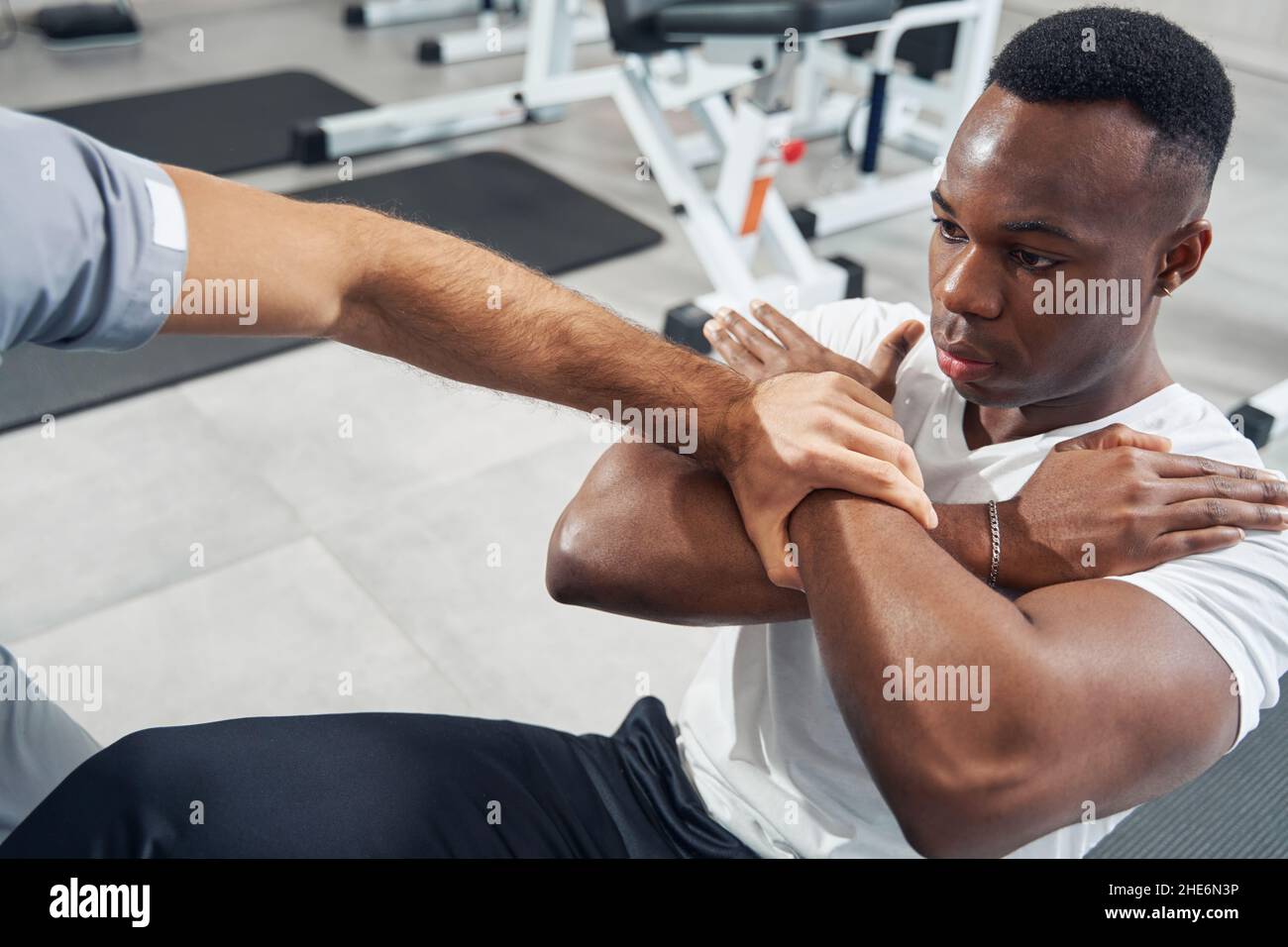 Young male patient undergoing muscle strength assessment Stock Photo ...