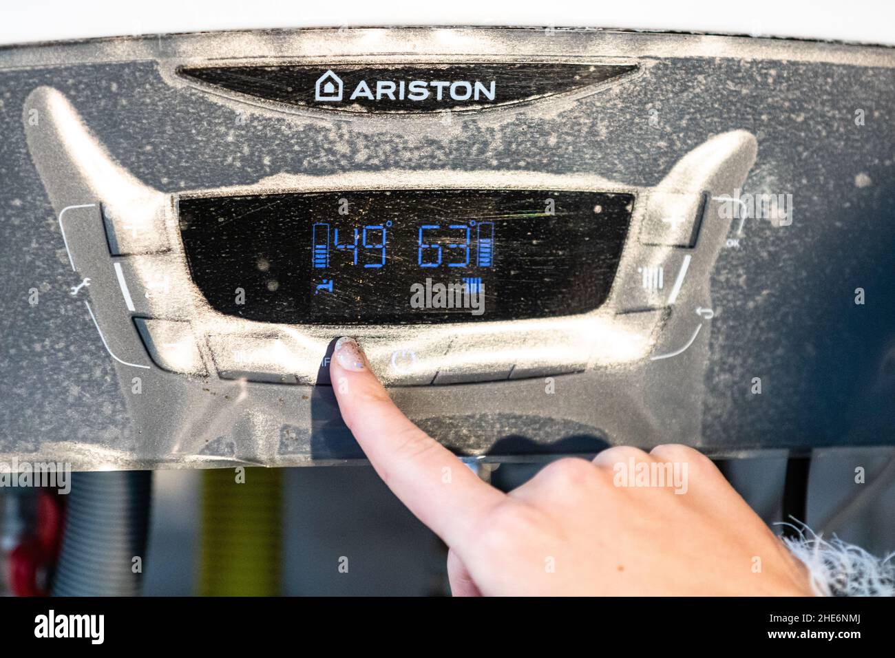 Girl hand setting temperature to heating system. Central heating ...