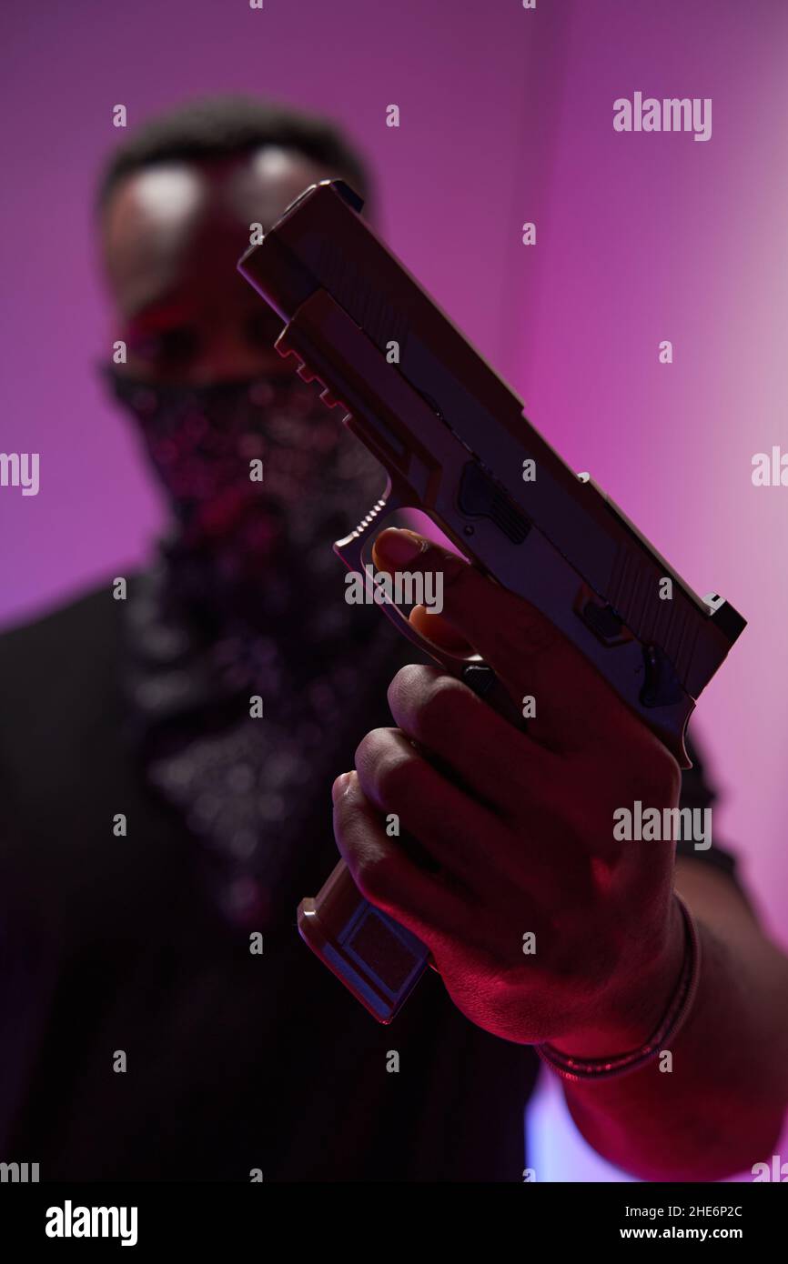 Person showing handgun to camera in studio Stock Photo - Alamy