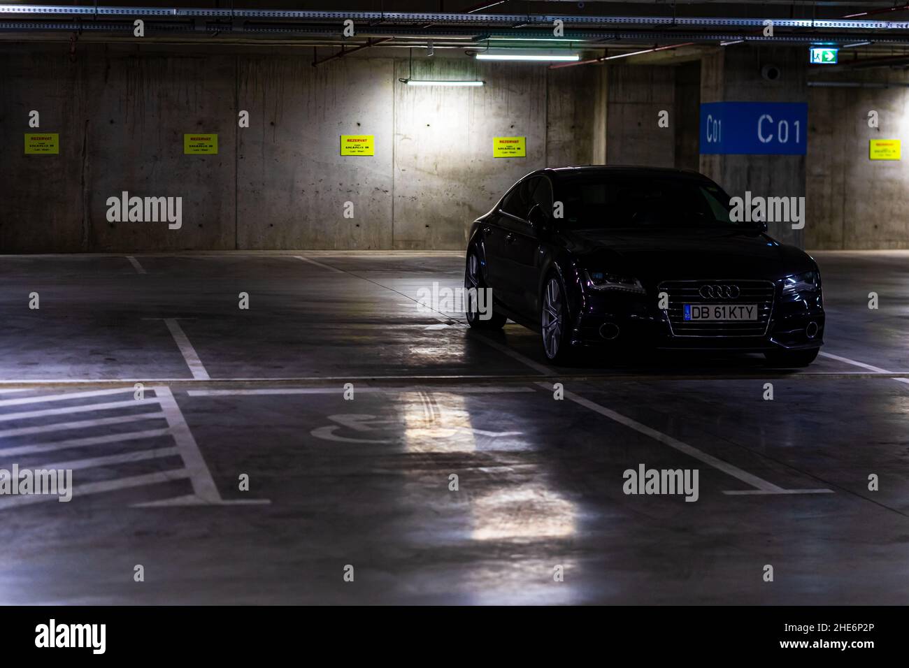 Parking garage interior with a few parked cars. Underground parking ...