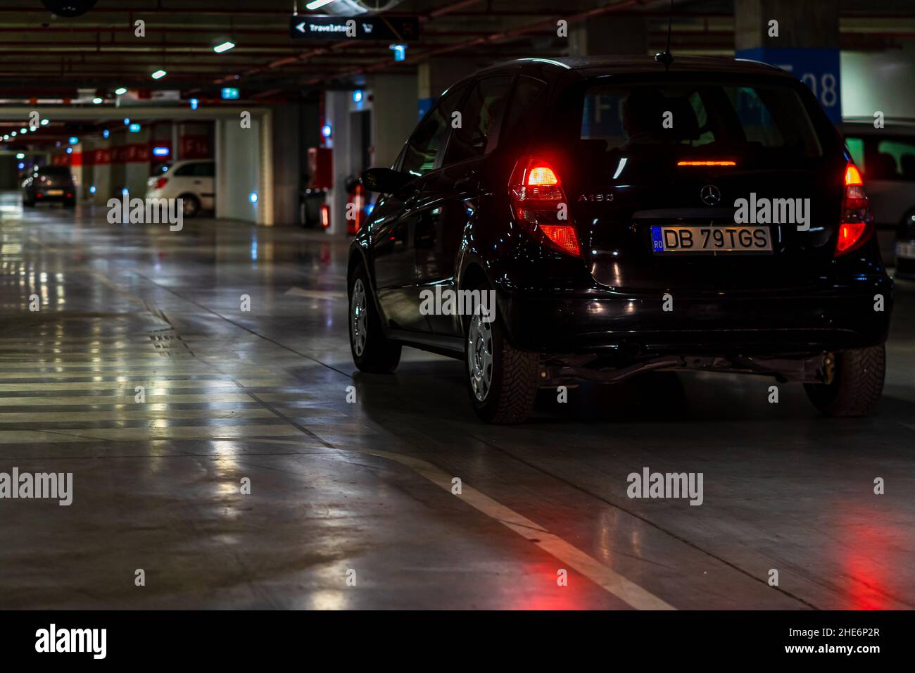 Parking garage interior with a few parked cars. Underground parking ...