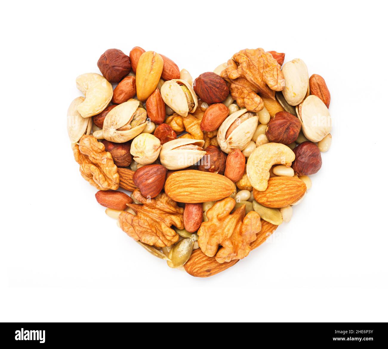 Heart shaped nuts and seeds isolated on white background close-up, flat ...