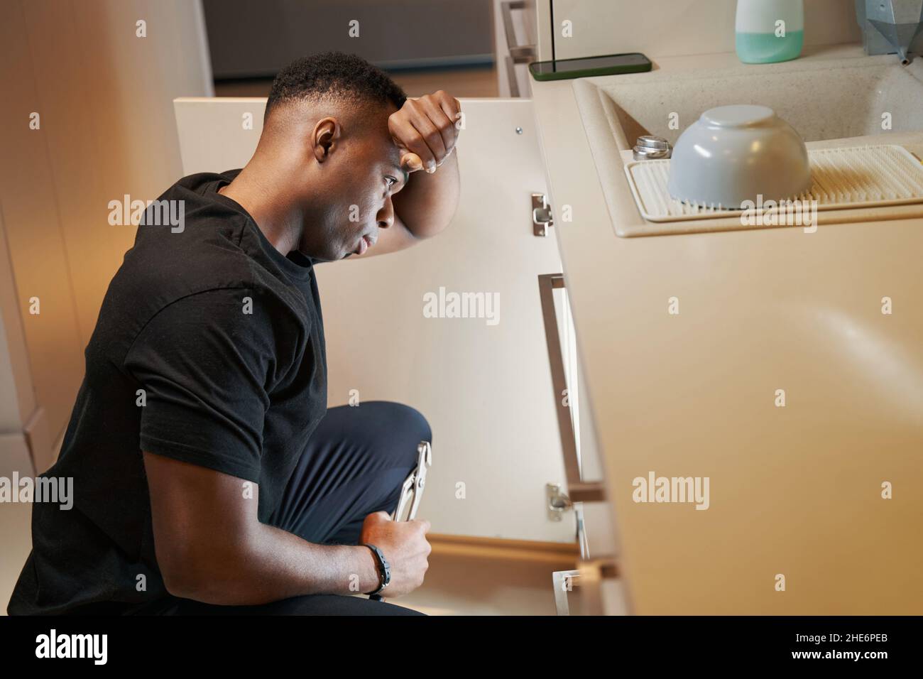 Multiethnic man wiping off sweat form his forehead Stock Photo - Alamy