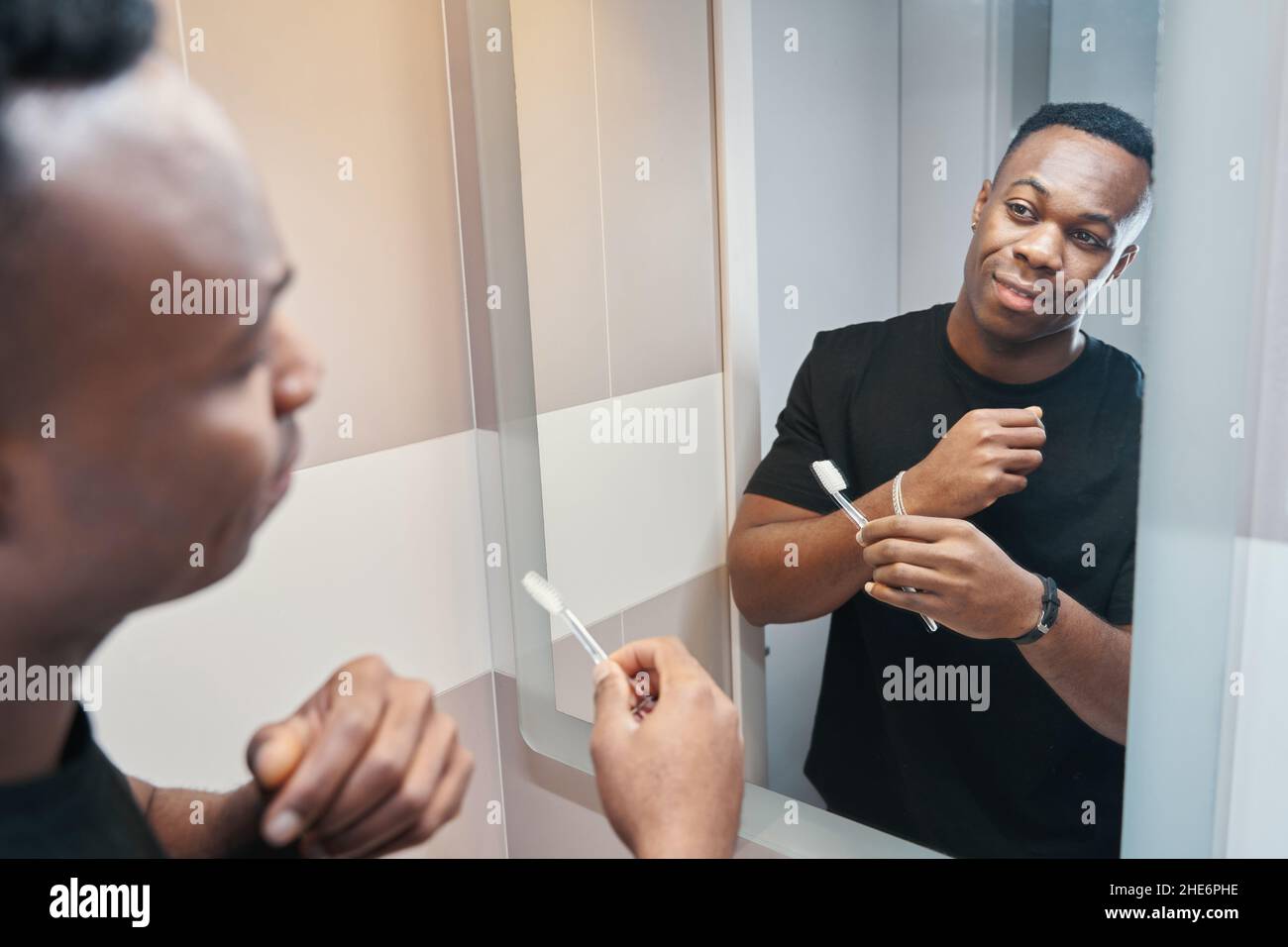 Multiethnic male getting ready to brush his teeth Stock Photo - Alamy