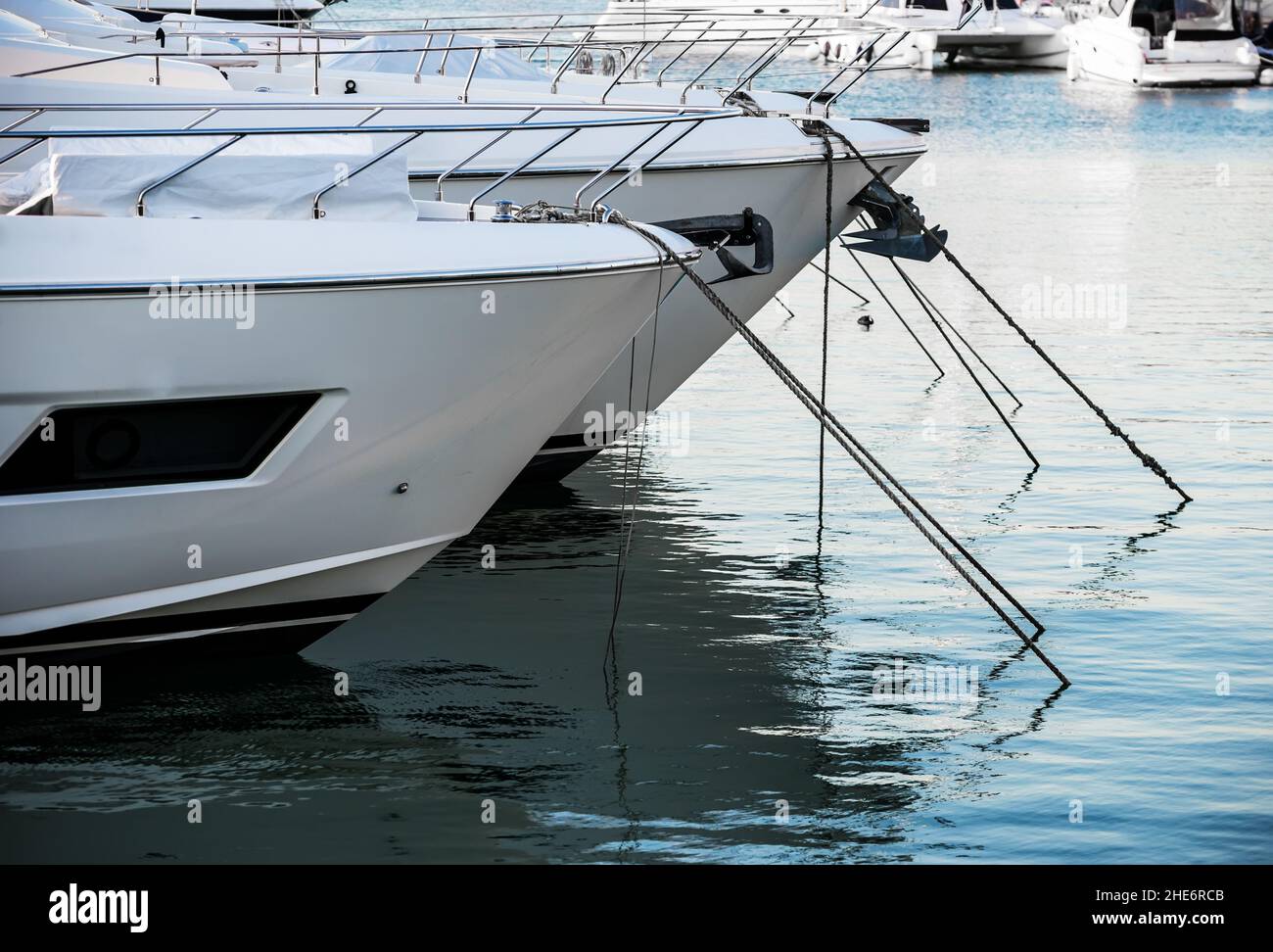 Luxury yachts docked in sea port at sunset. Marine parking of modern ...