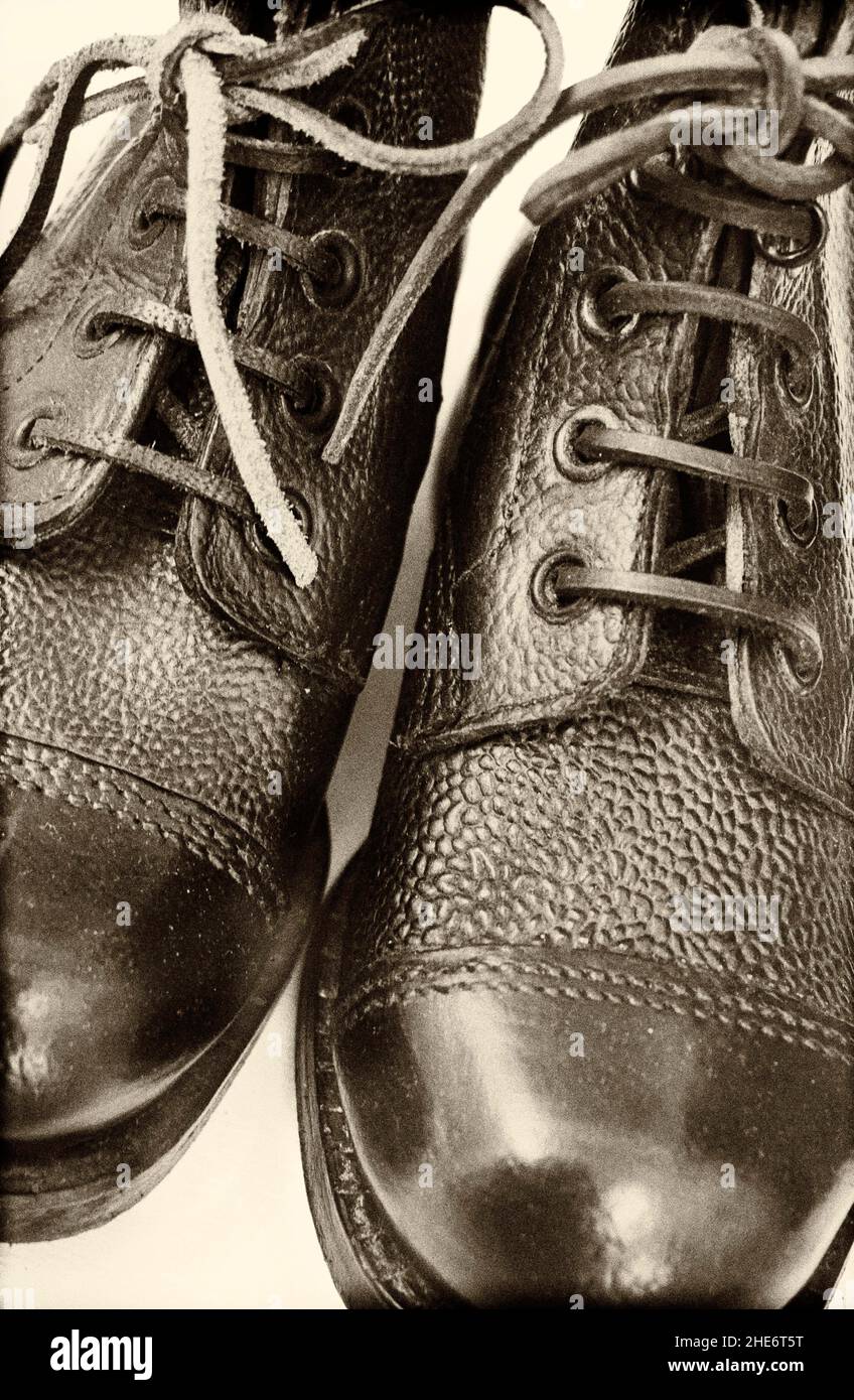 pair of old fashioned laced up leather work boots Stock Photo - Alamy