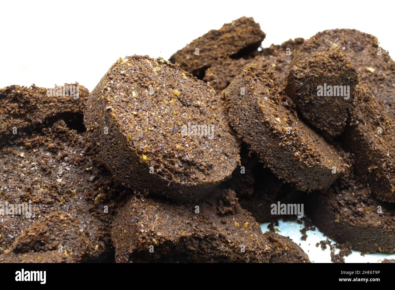 Closeup of isolated pile pressed coffee grounds tabs from automatic ...