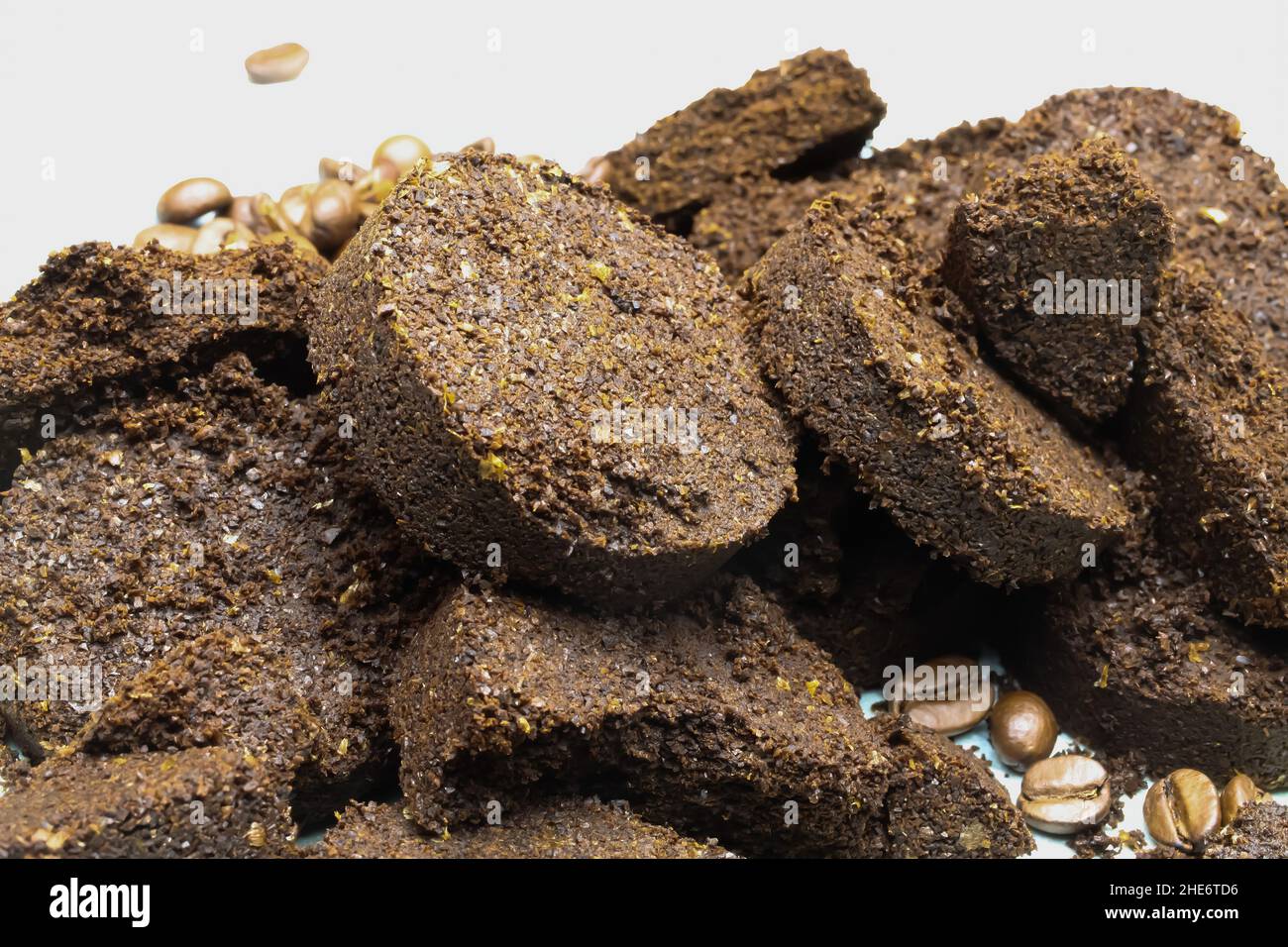 Closeup of isolated pile pressed coffee grounds tabs from automatic ...