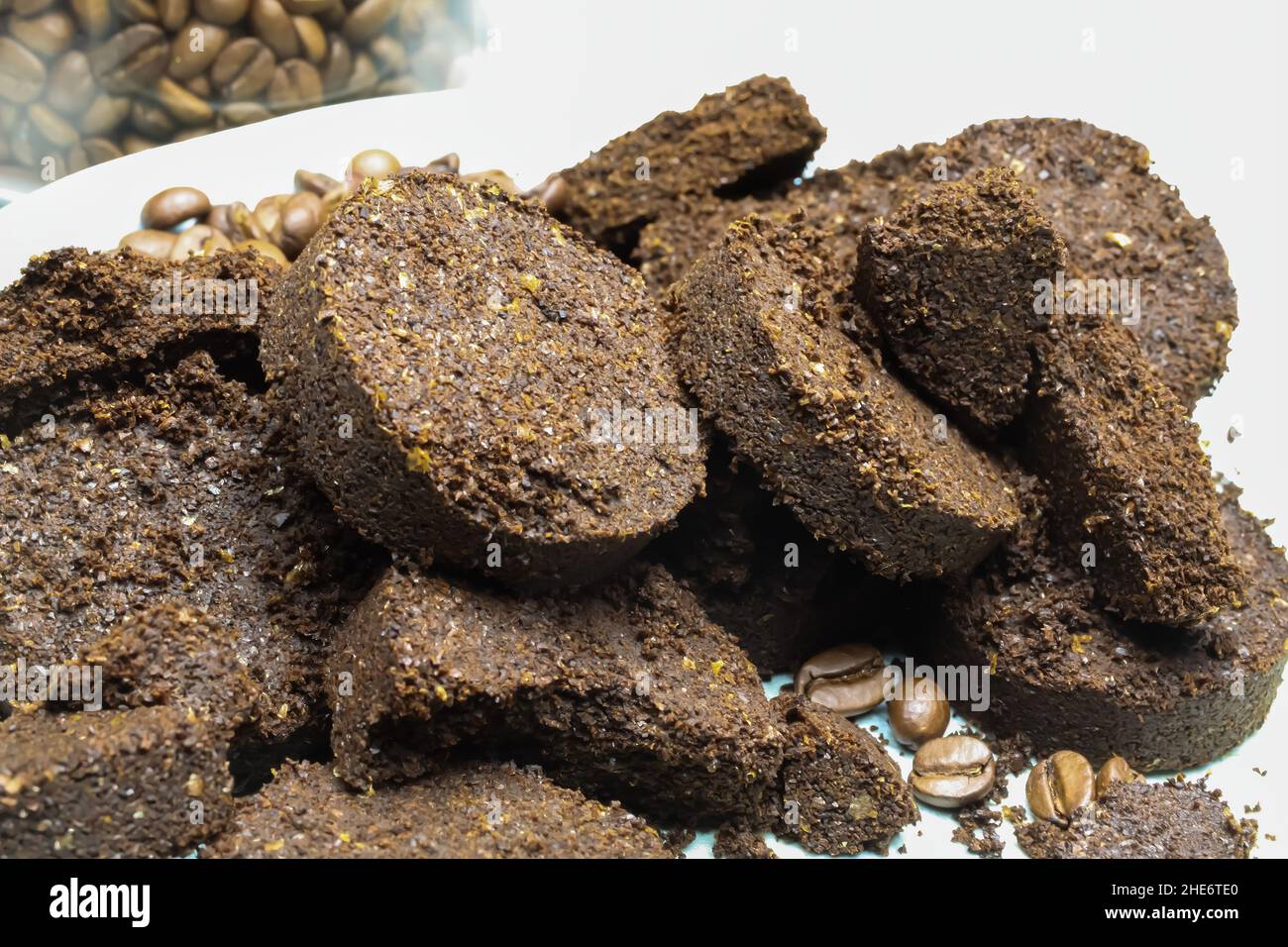 Closeup of isolated pile pressed coffee grounds tabs from automatic ...