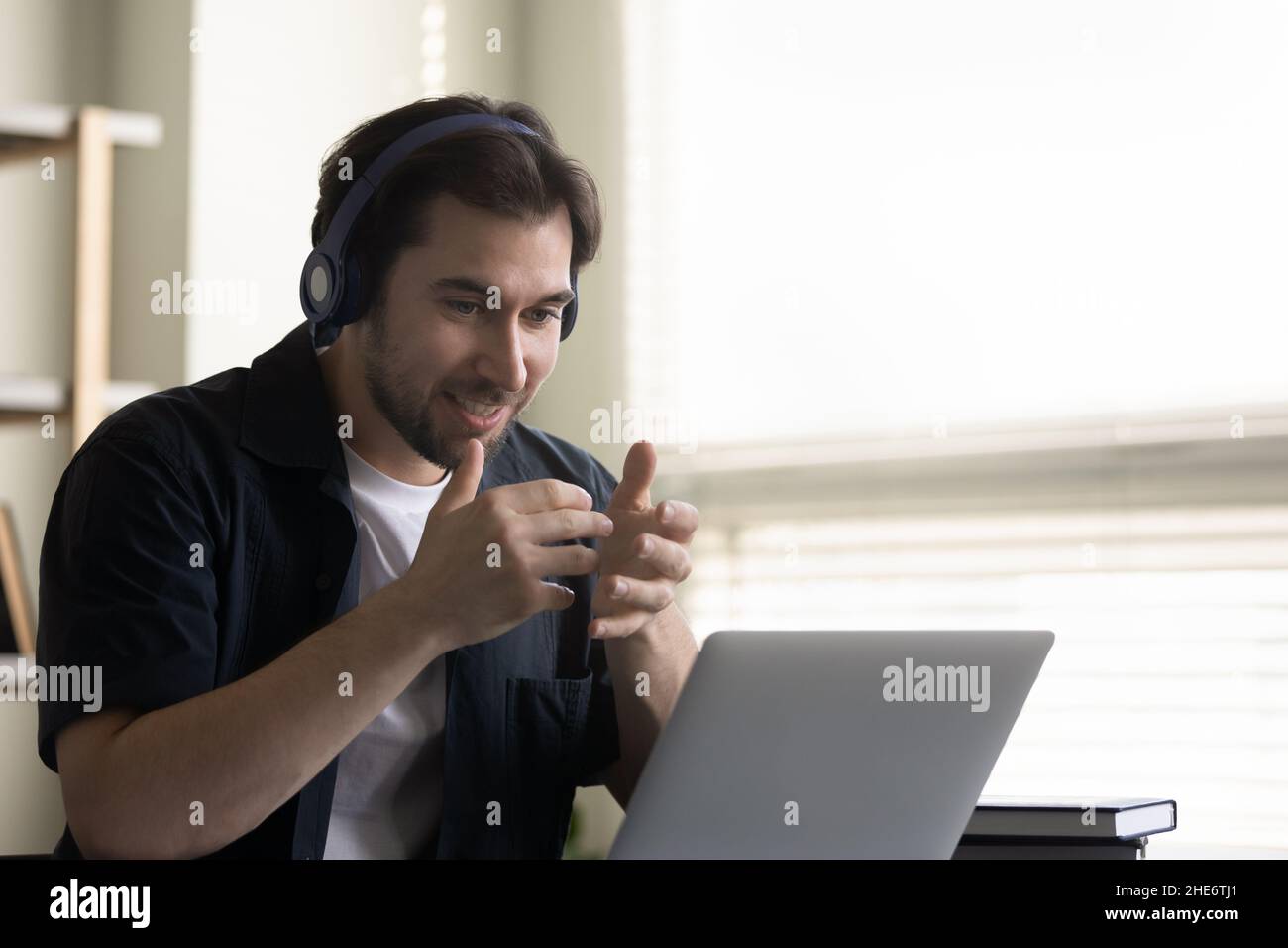 Happy inspired young Caucasian man holding video call conversation ...