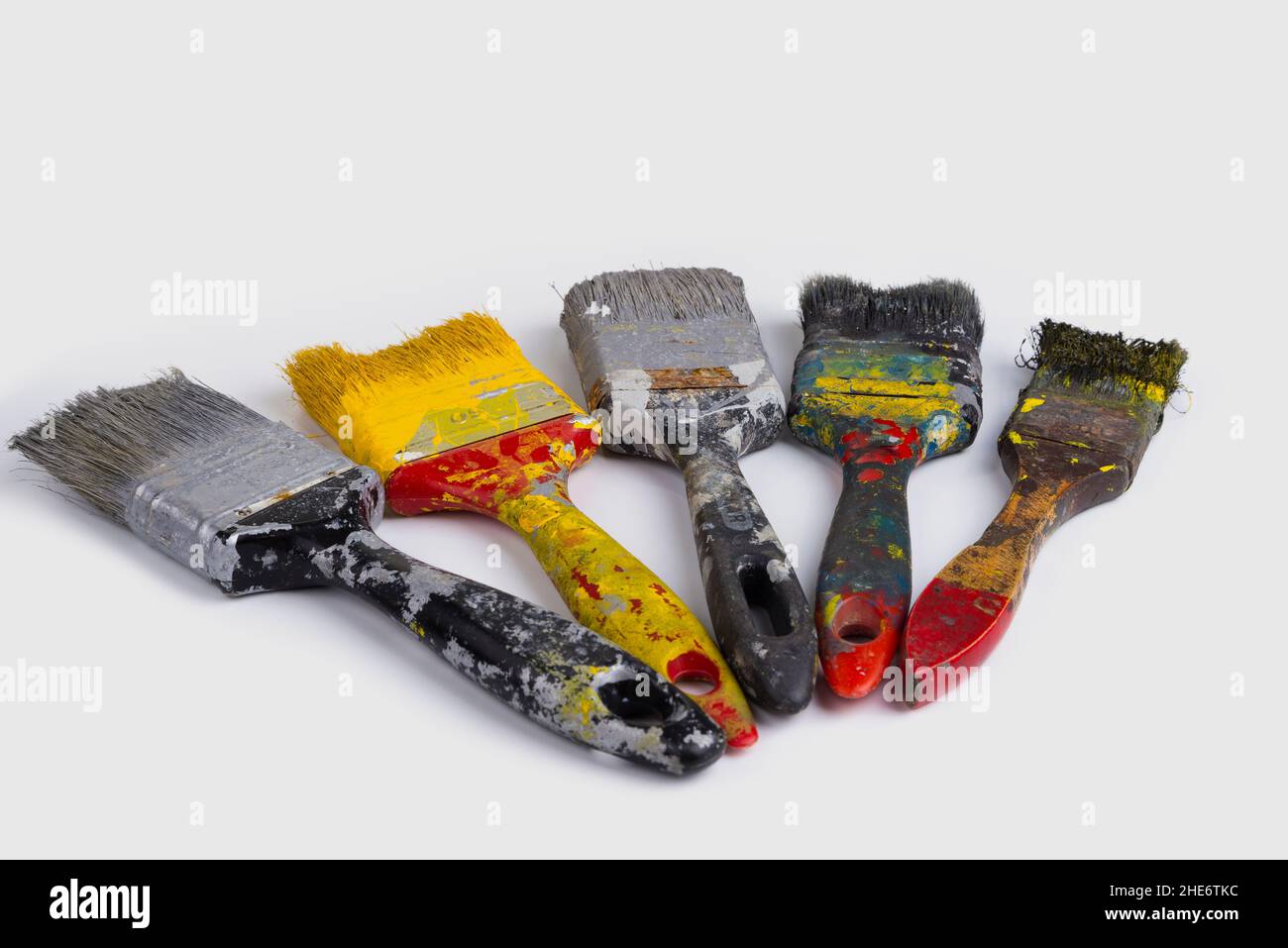 Bunch of old used brushes on a white background Stock Photo - Alamy