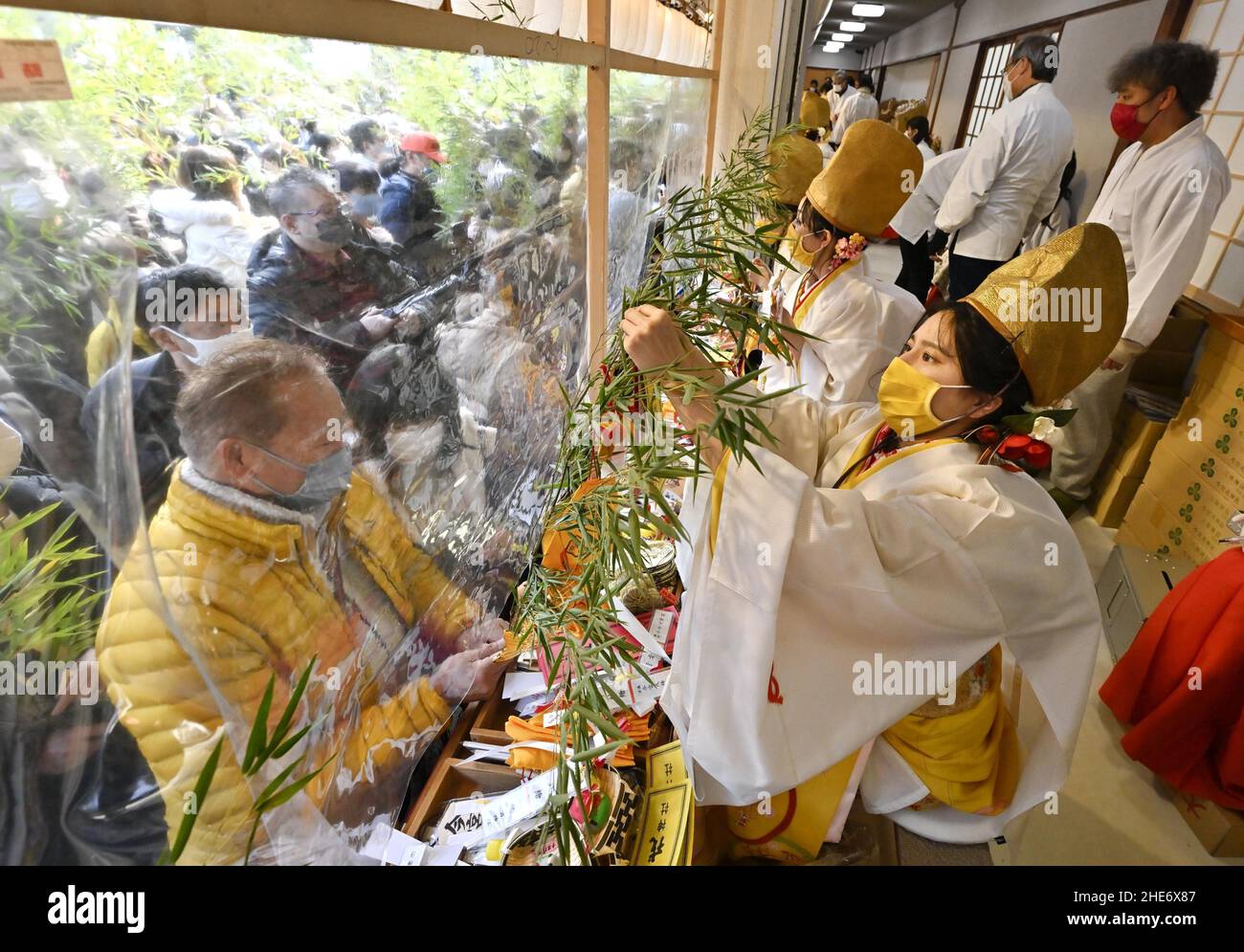 "Fuku musume" (lucky girls) put lucky charms on visitors' bamboo branches at the Imamiya Ebisu ...