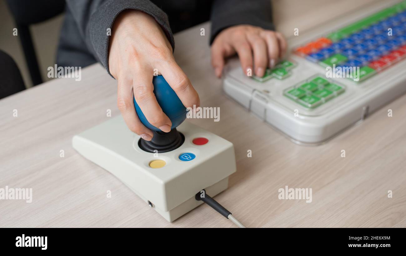 Woman with cerebral palsy works on a specialized computer mouse Stock ...