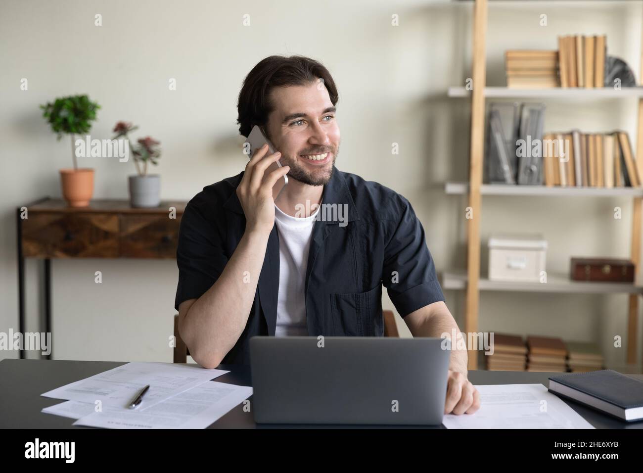 Happy friendly millennial employee multitasking in modern office Stock ...