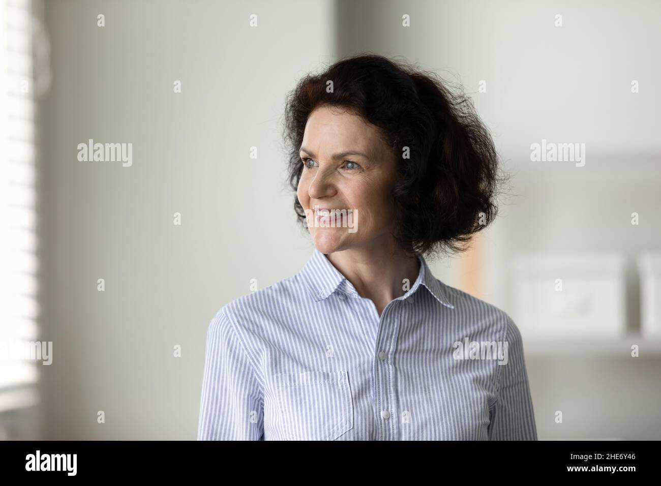 Happy dreamy old woman looking in distance Stock Photo - Alamy