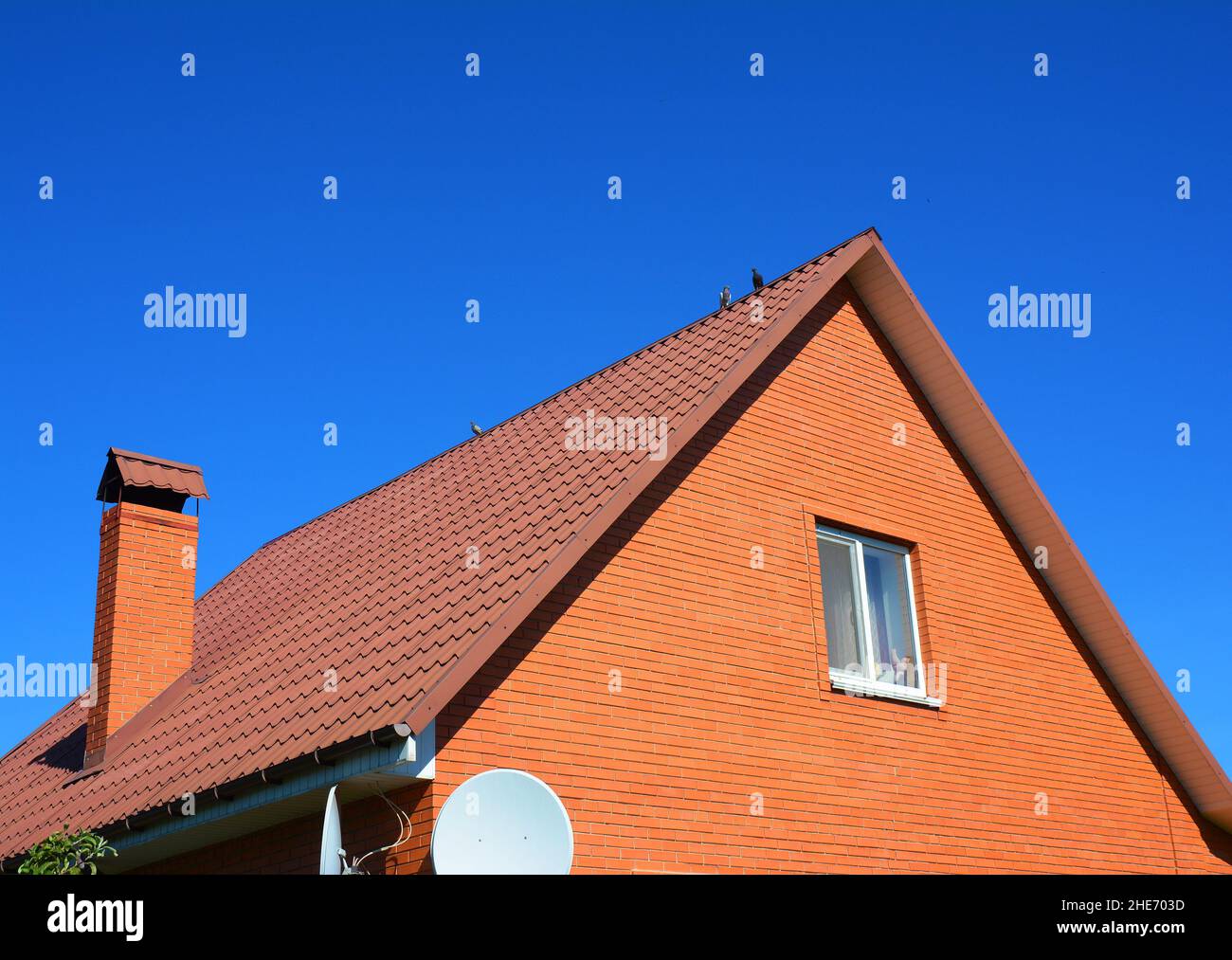Metal Roofing New Brick House Stock Photo - Alamy