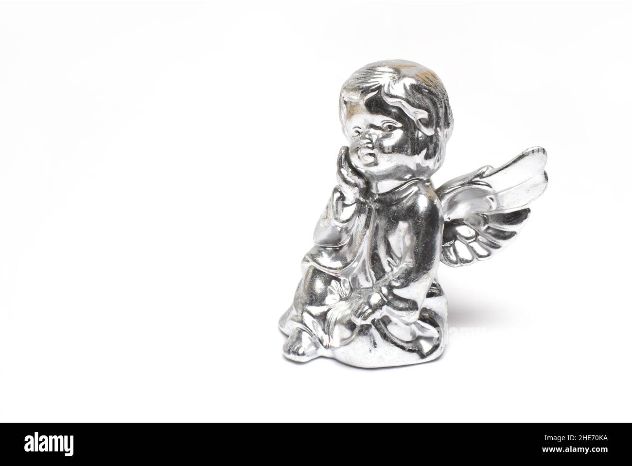Close up of silver angel cast from clay on white background Stock Photo ...