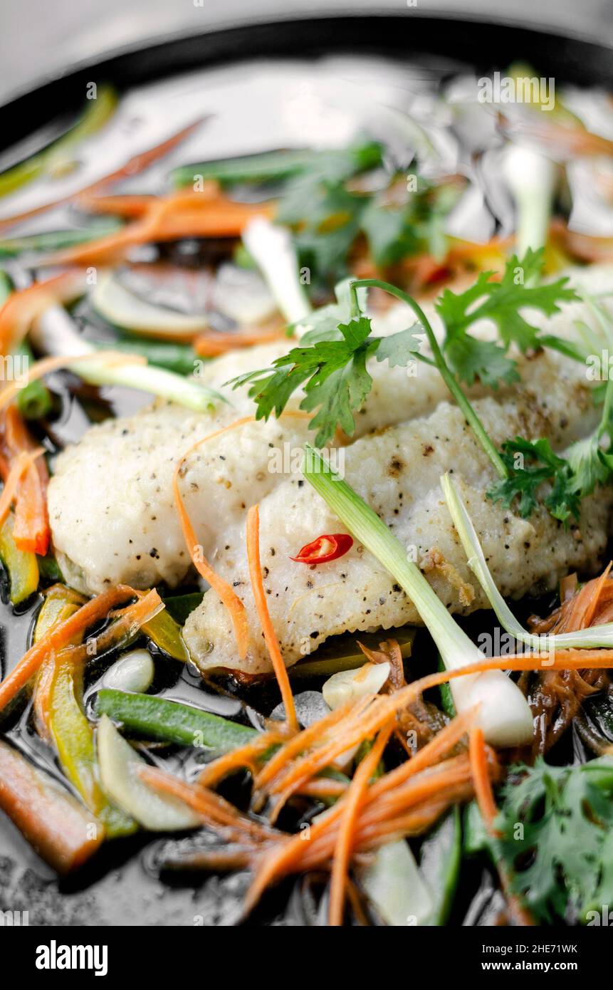 chinese cantonese style steamed spicy fish fillet with vegetables on ...