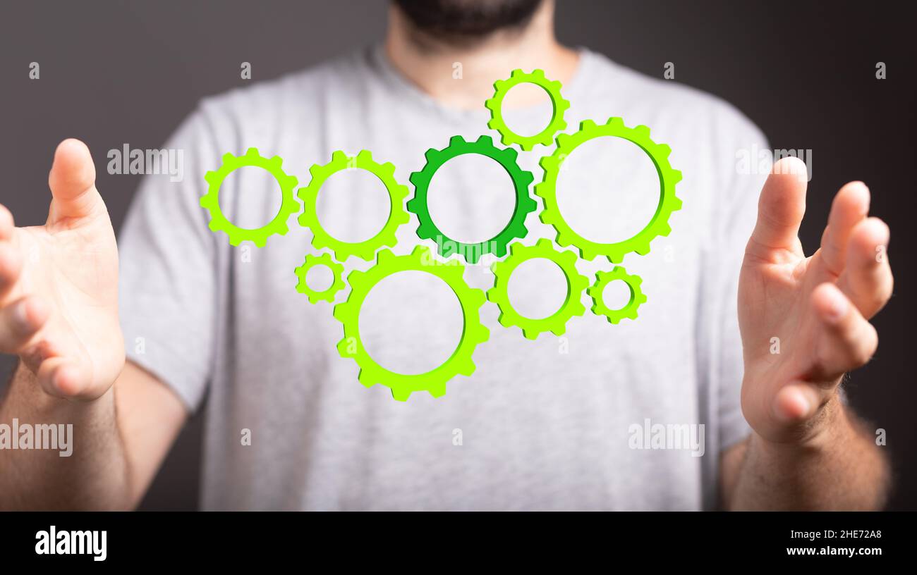 3d rendering of man touching mechanism, green metallic gears, and cogs ...