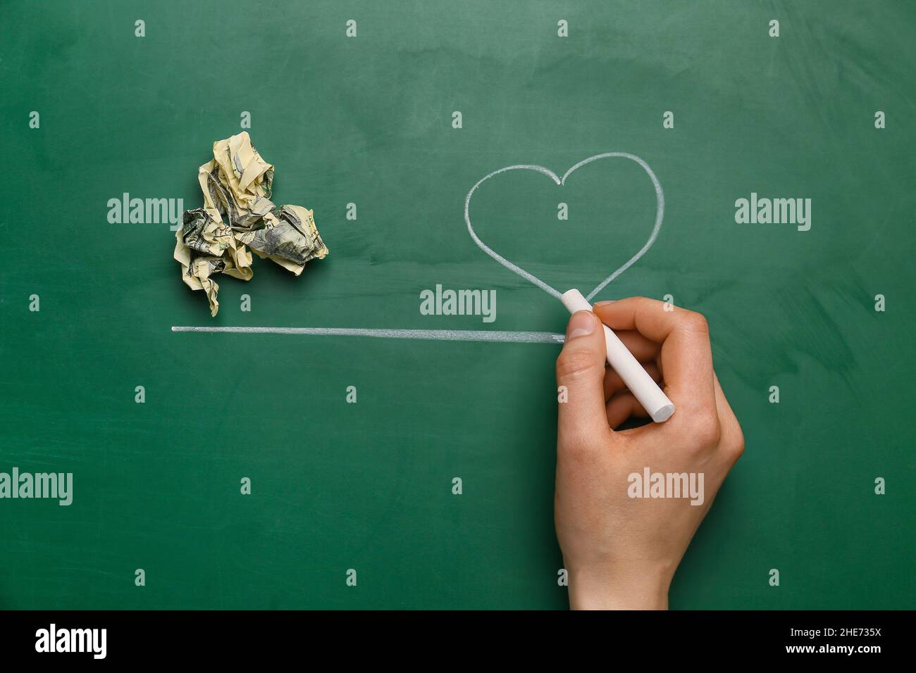 Female hand drawing heart and scales with crumpled money. Concept of ...