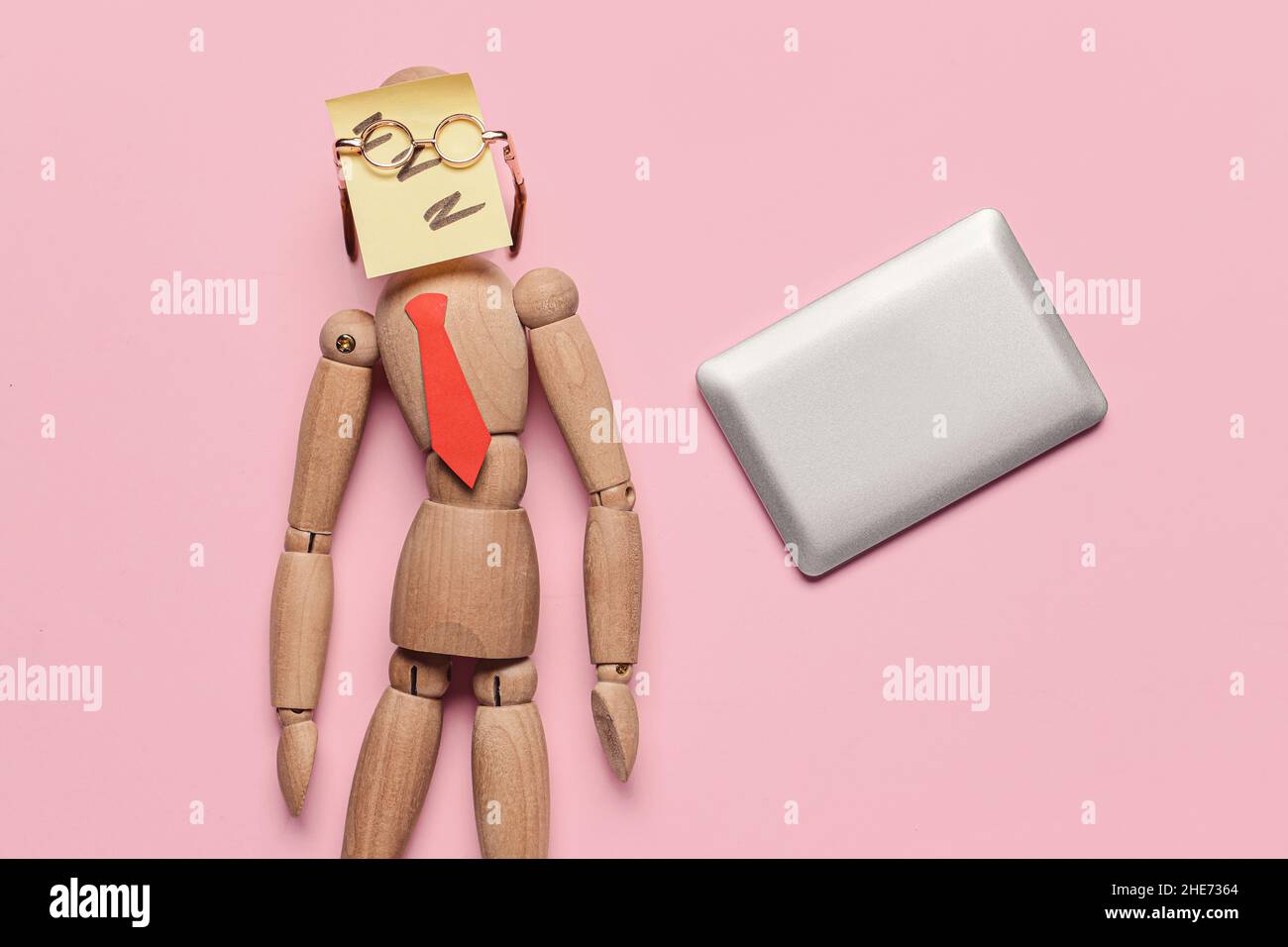 Funny sleeping mannequin with tiny laptop on color background Stock ...