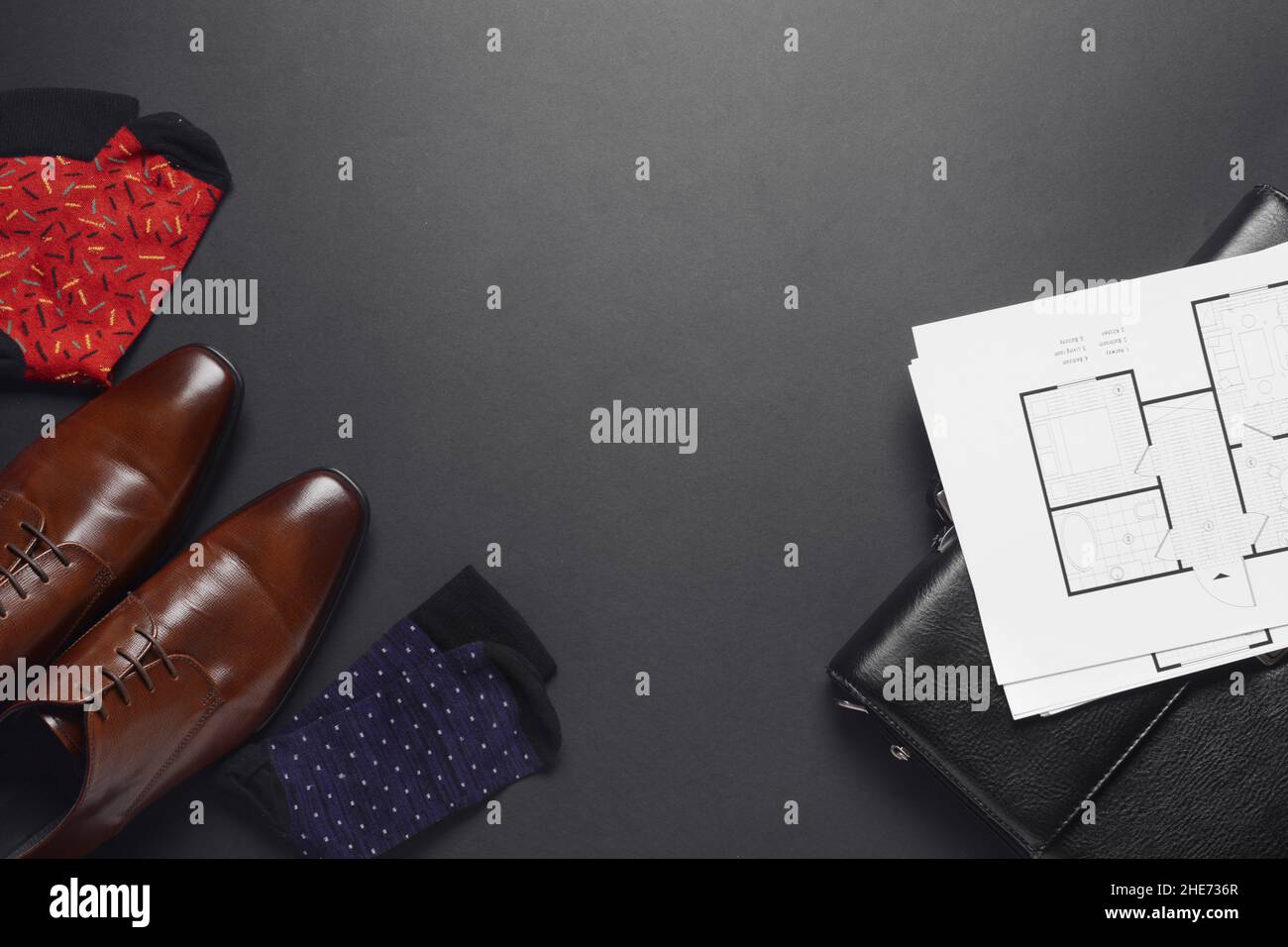 Shoes with socks, briefcase and drawings on dark background Stock Photo ...