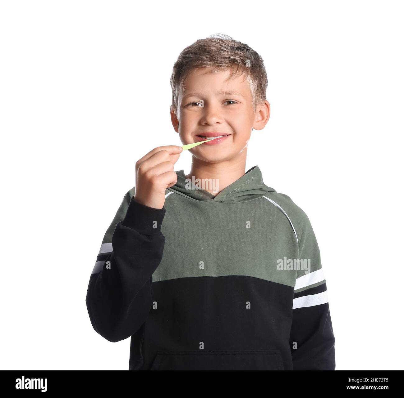 Little boy in hoodie chewing gum on white background Stock Photo - Alamy