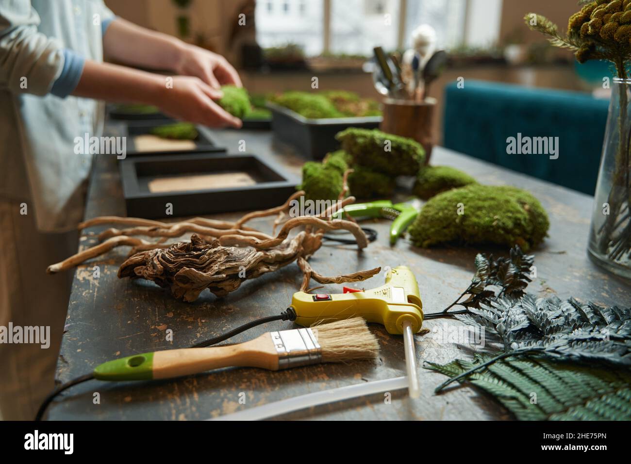 Creative woman making picture with green plants Stock Photo - Alamy