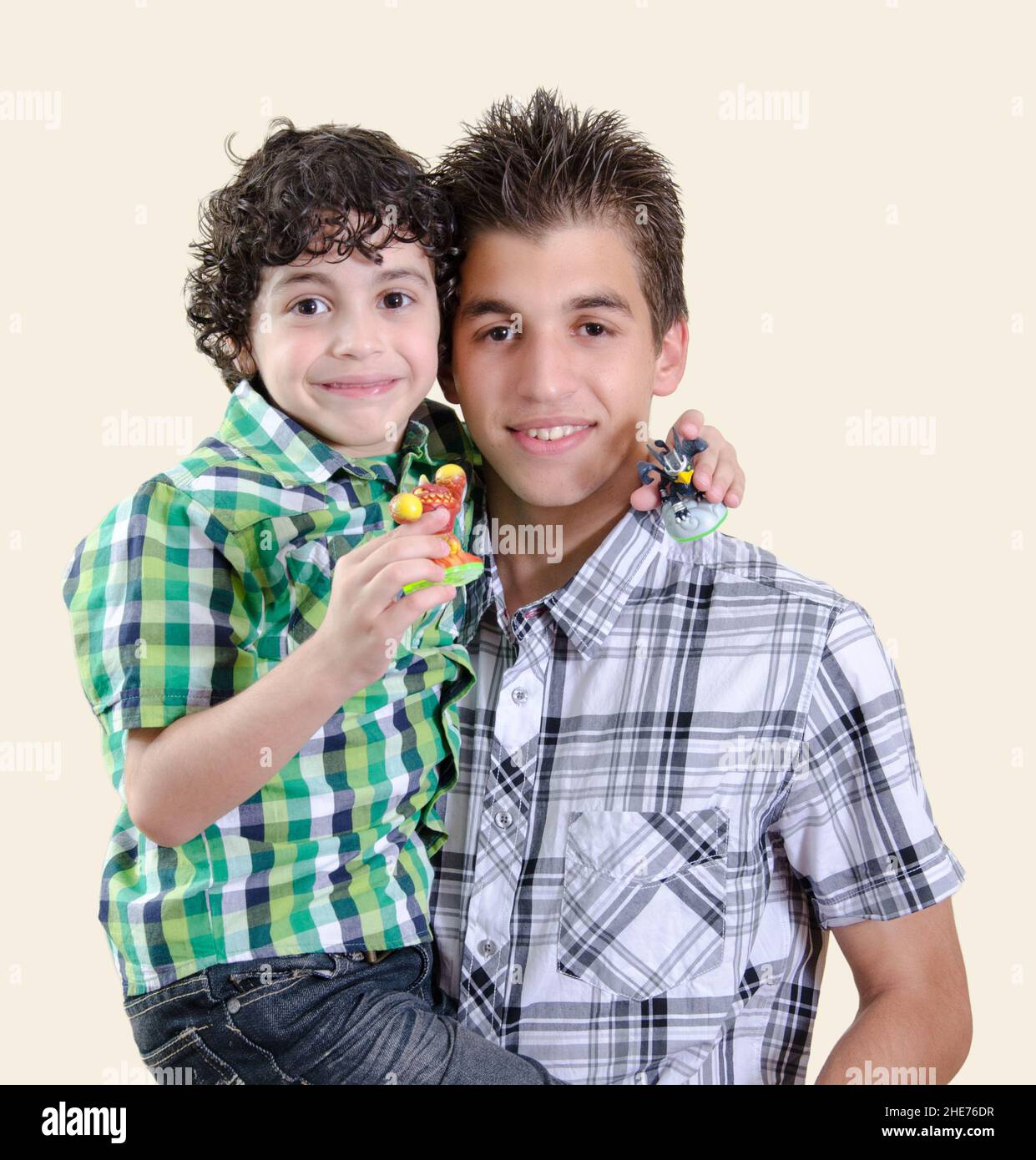 Real birthday celebration: Teenage boy holding young boy with ...