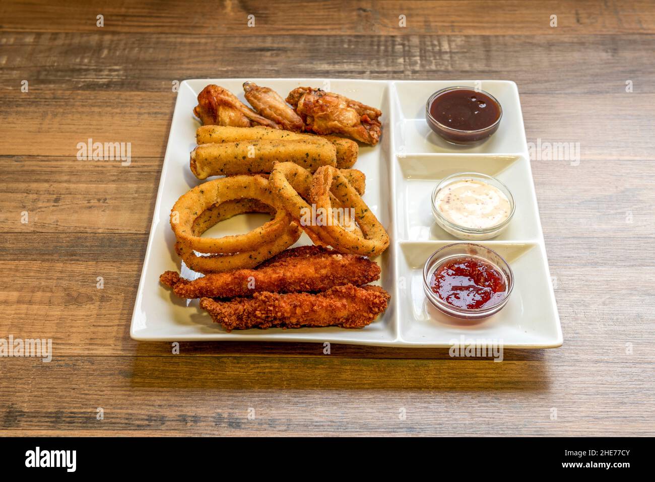 Combo of tex mex snacks with chicken strips, onion rings, cheese ...