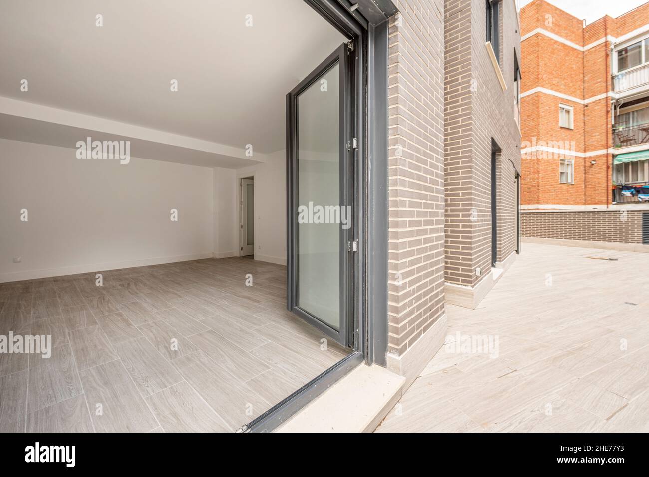 Black aluminum bay window into a living room from a ground floor patio ...