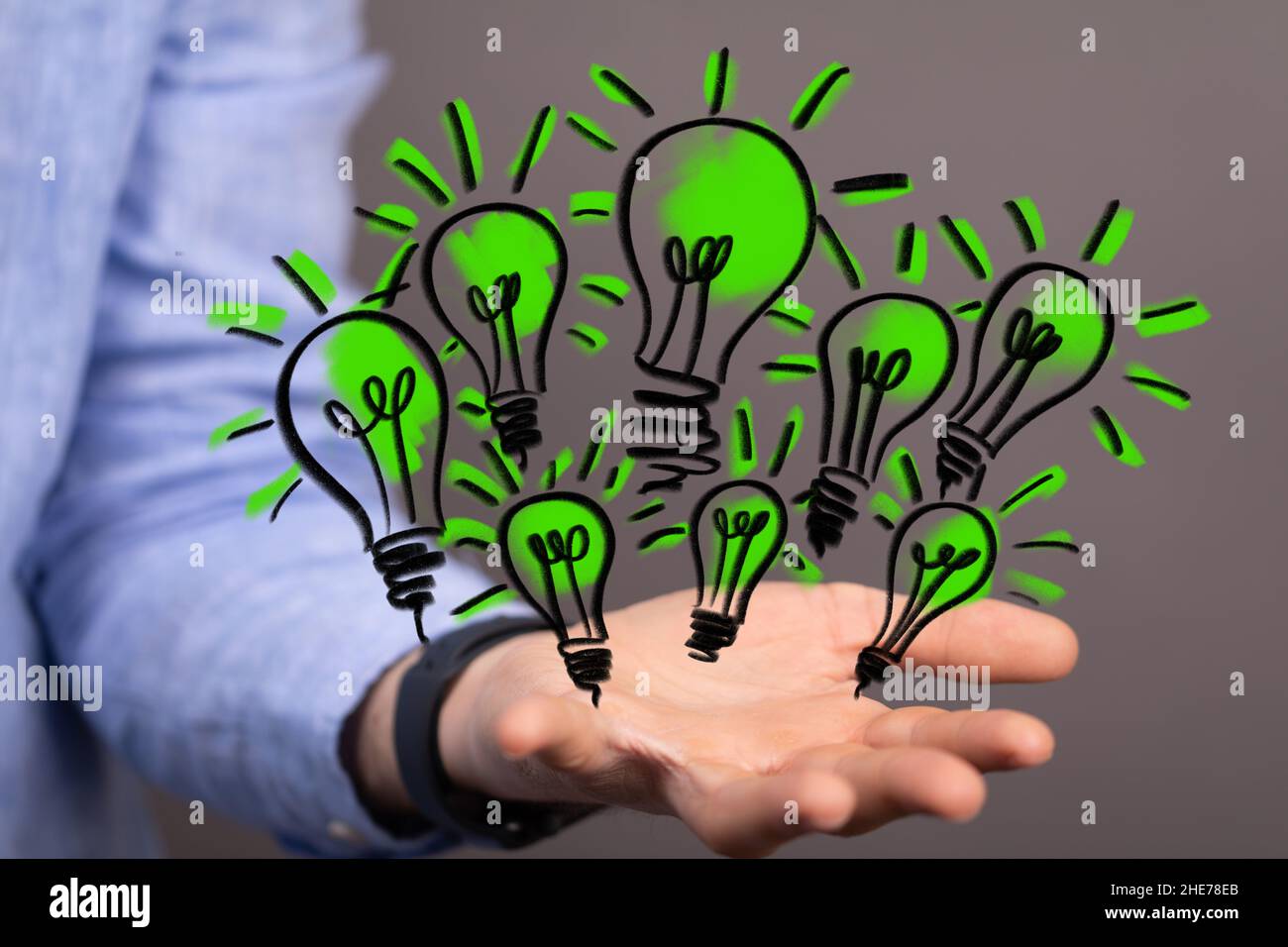 3d rendering of hands holding green light bulb symbols Stock Photo - Alamy