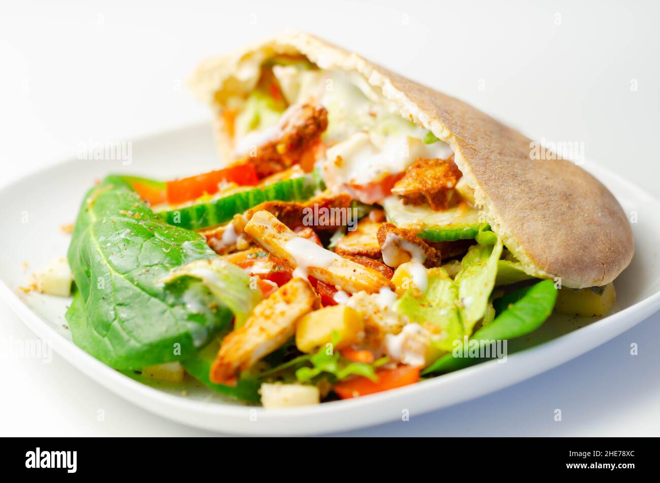 Mediterranean style pitta prepared with spicy chicken, cucumber, tomato ...