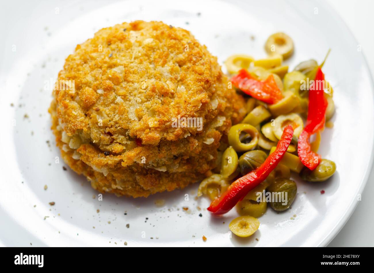 Cod and prawns red Thai style fish cake served with pickled olives ...