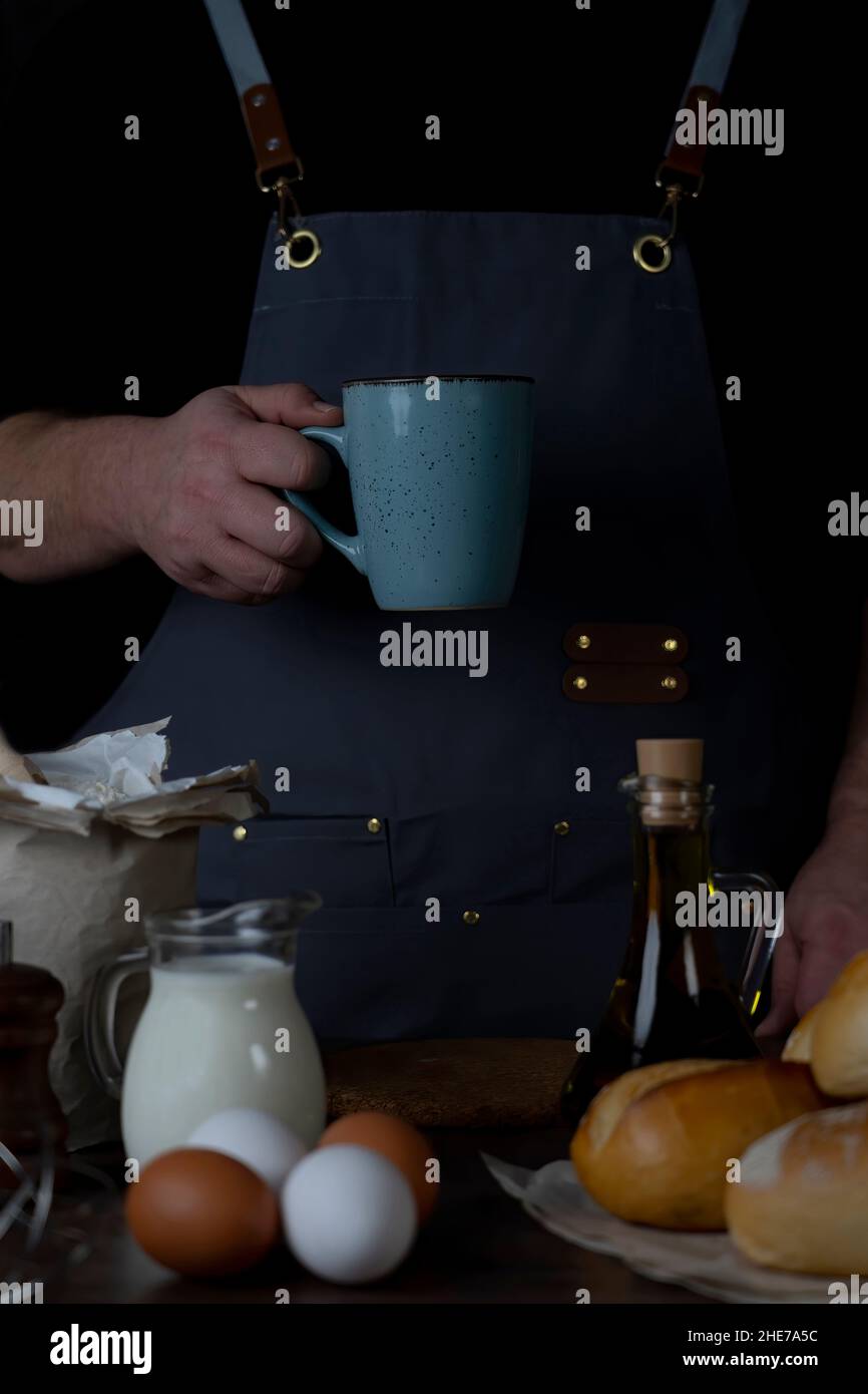 Working baker Man holding with his hand a cup,in his Break Stock Photo ...