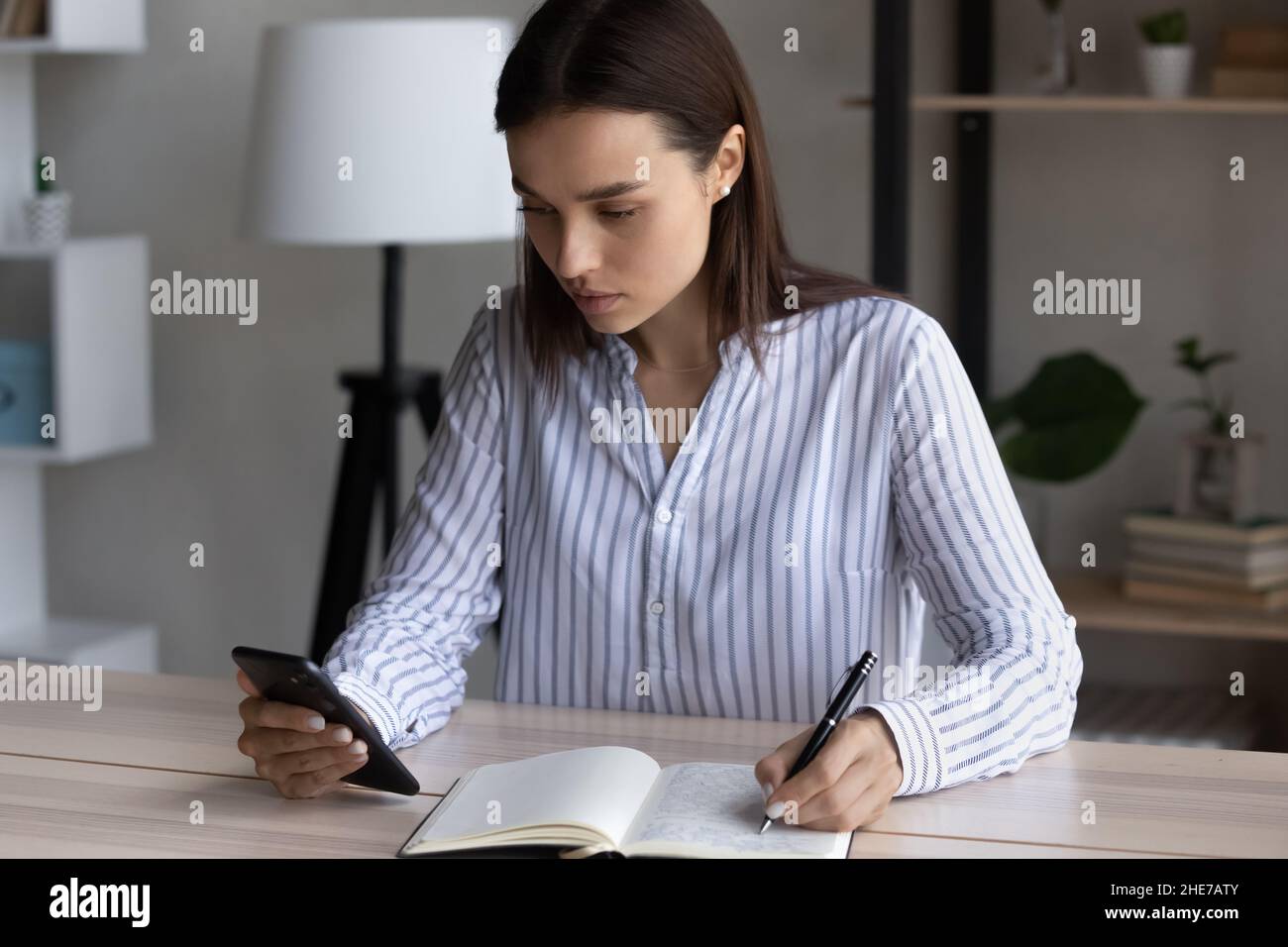 Serious busy millennial student girl watching learning webinar Stock ...