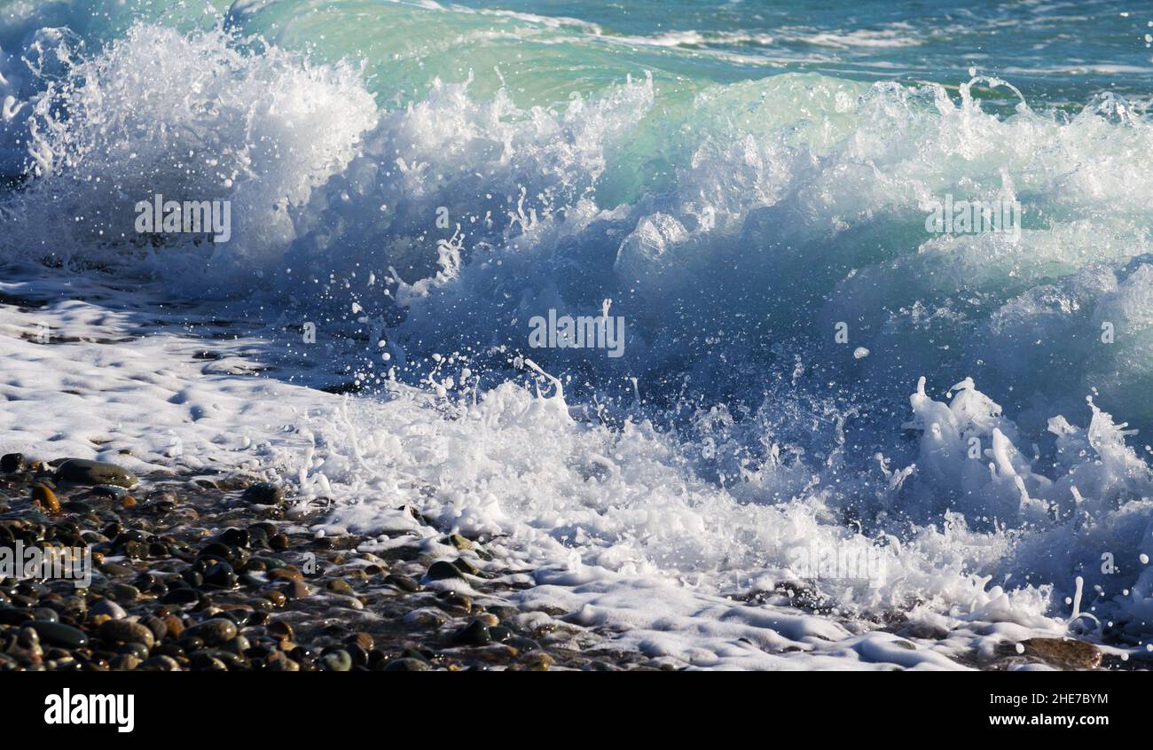 Blue wave breaking on a beach in sea Stock Photo - Alamy