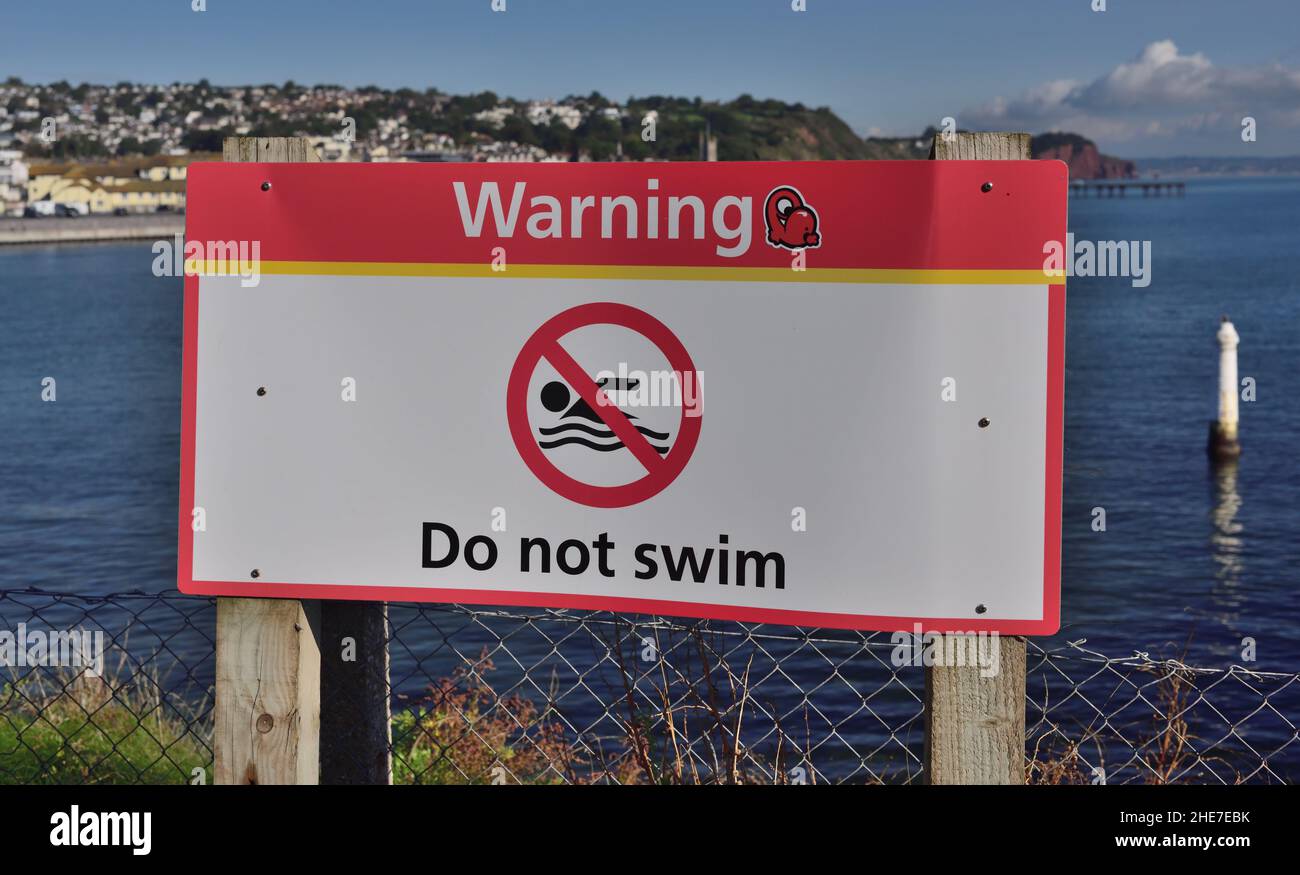 Warning Do not swim sign above the river Teign estuary, looking towards ...