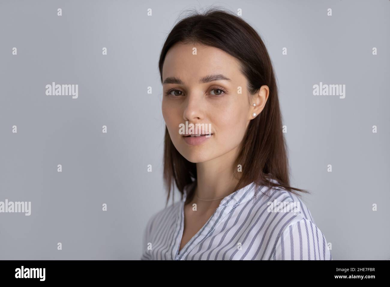 Portrait of beautiful young millennial Caucasian girl looking at camera ...